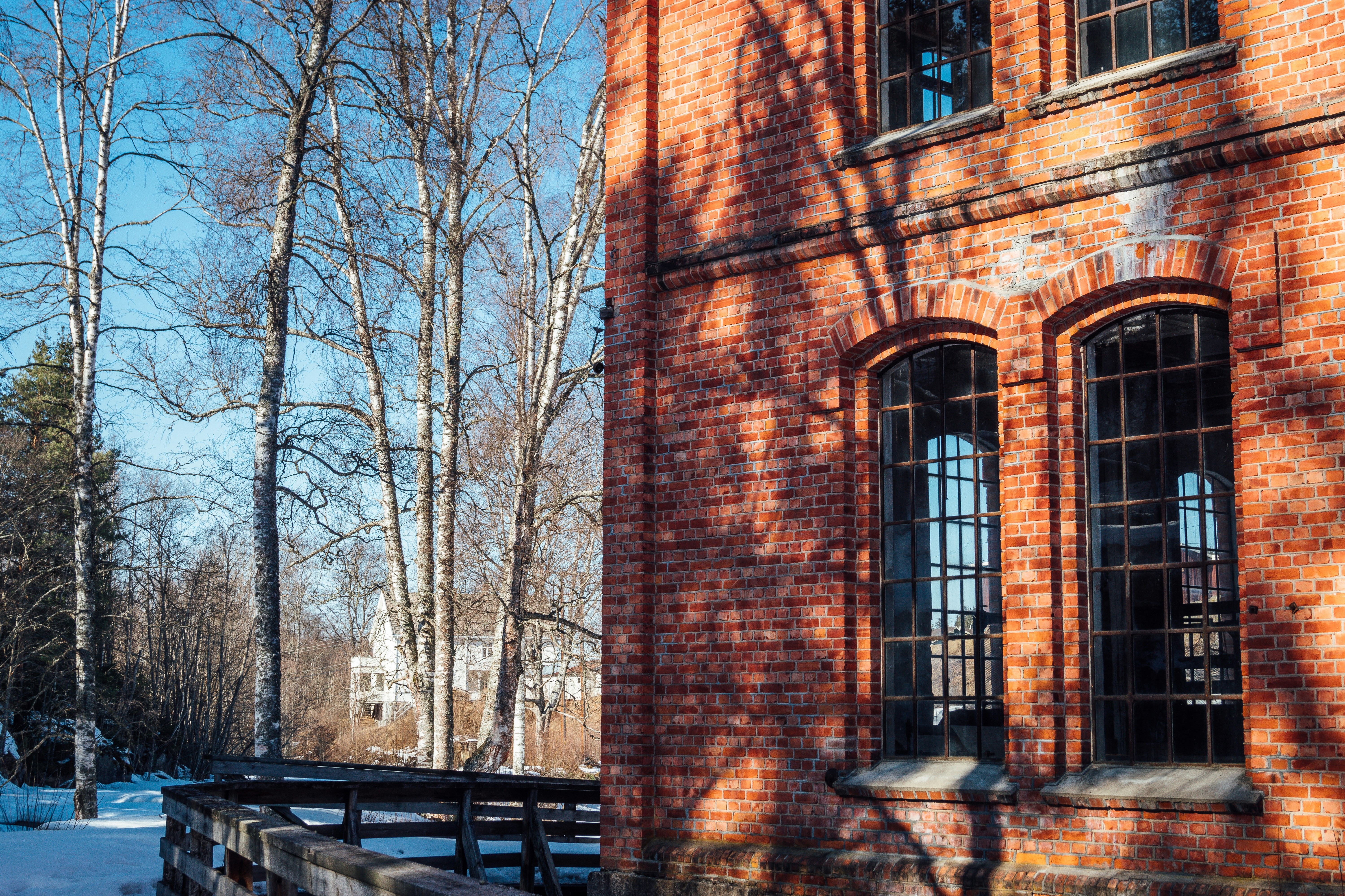 Winter Light on Red Brick: Arched Facade in Quiet Snow