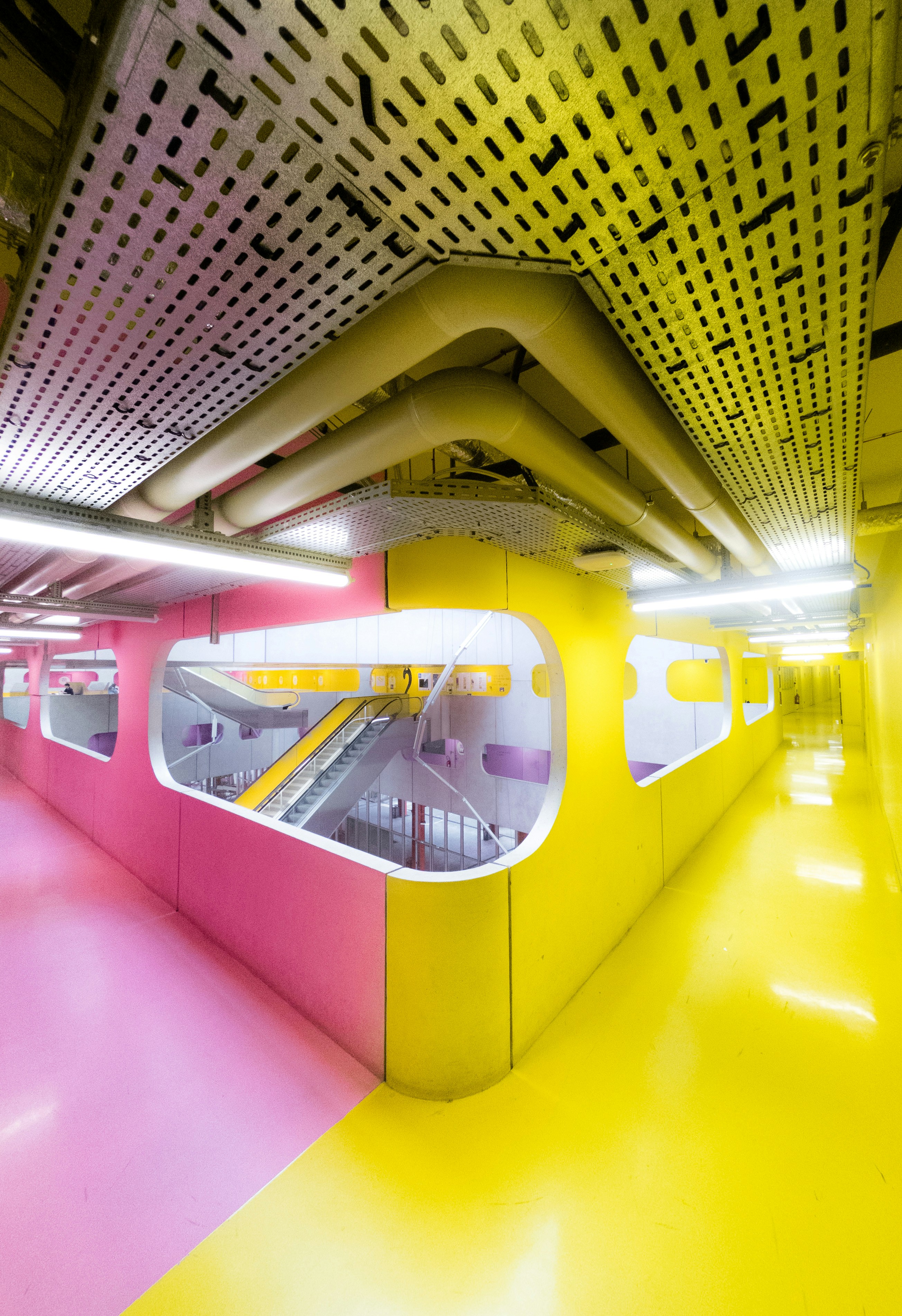 A yellow and pink subway station with a ramp photo – Free France Image ...
