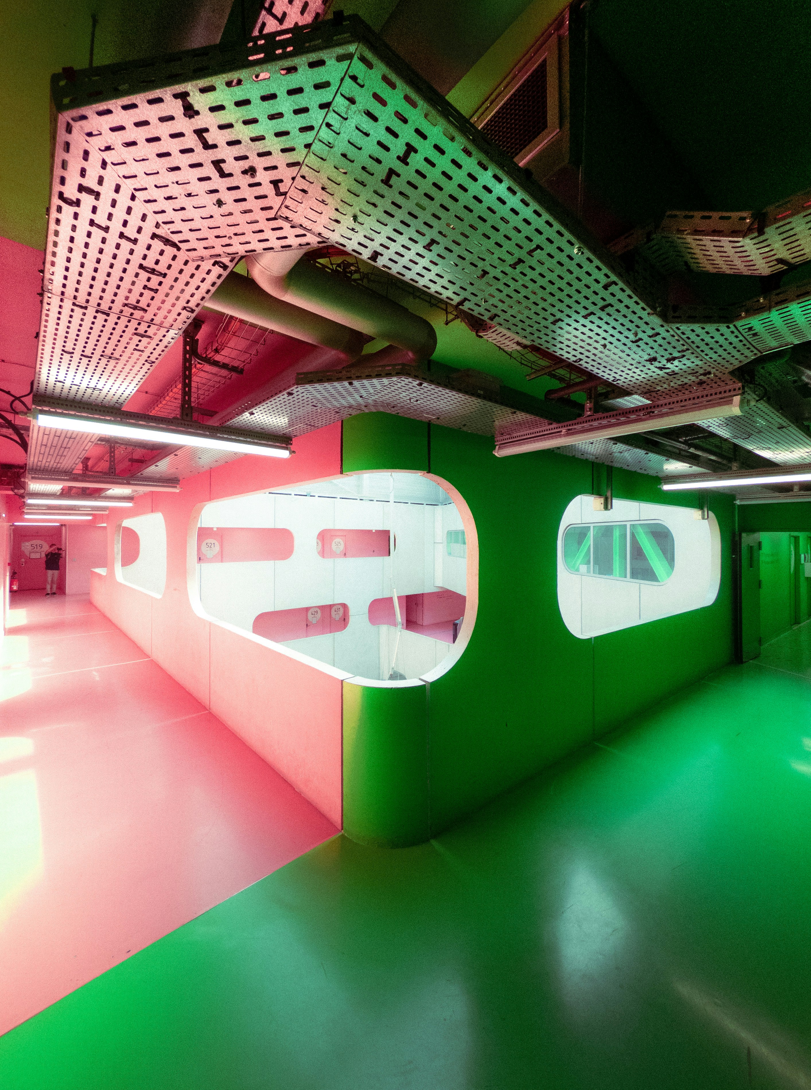 Neon Corridor of Colored Pods