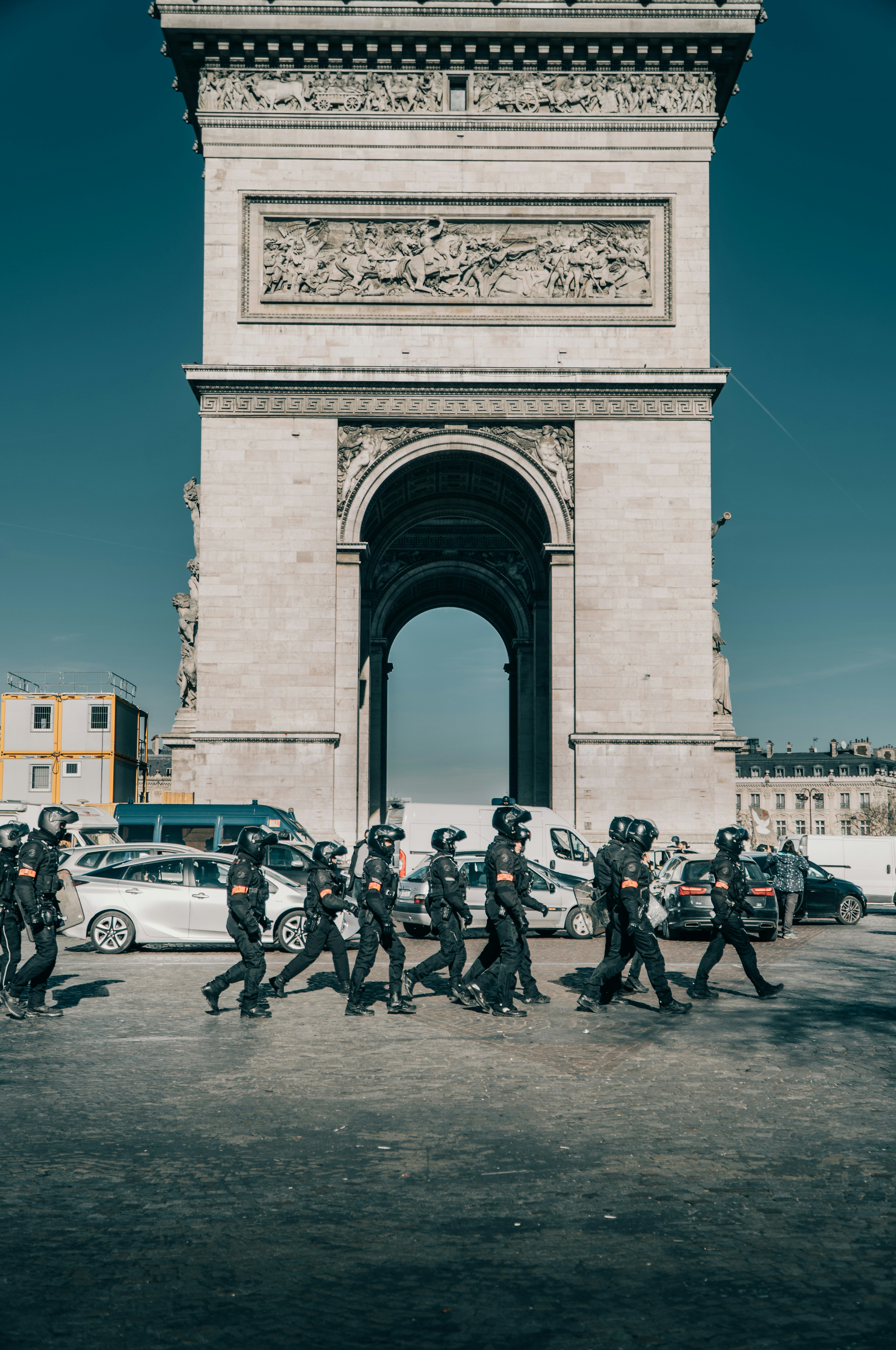 A group of police officers walking in front of a monument photo – Free ...