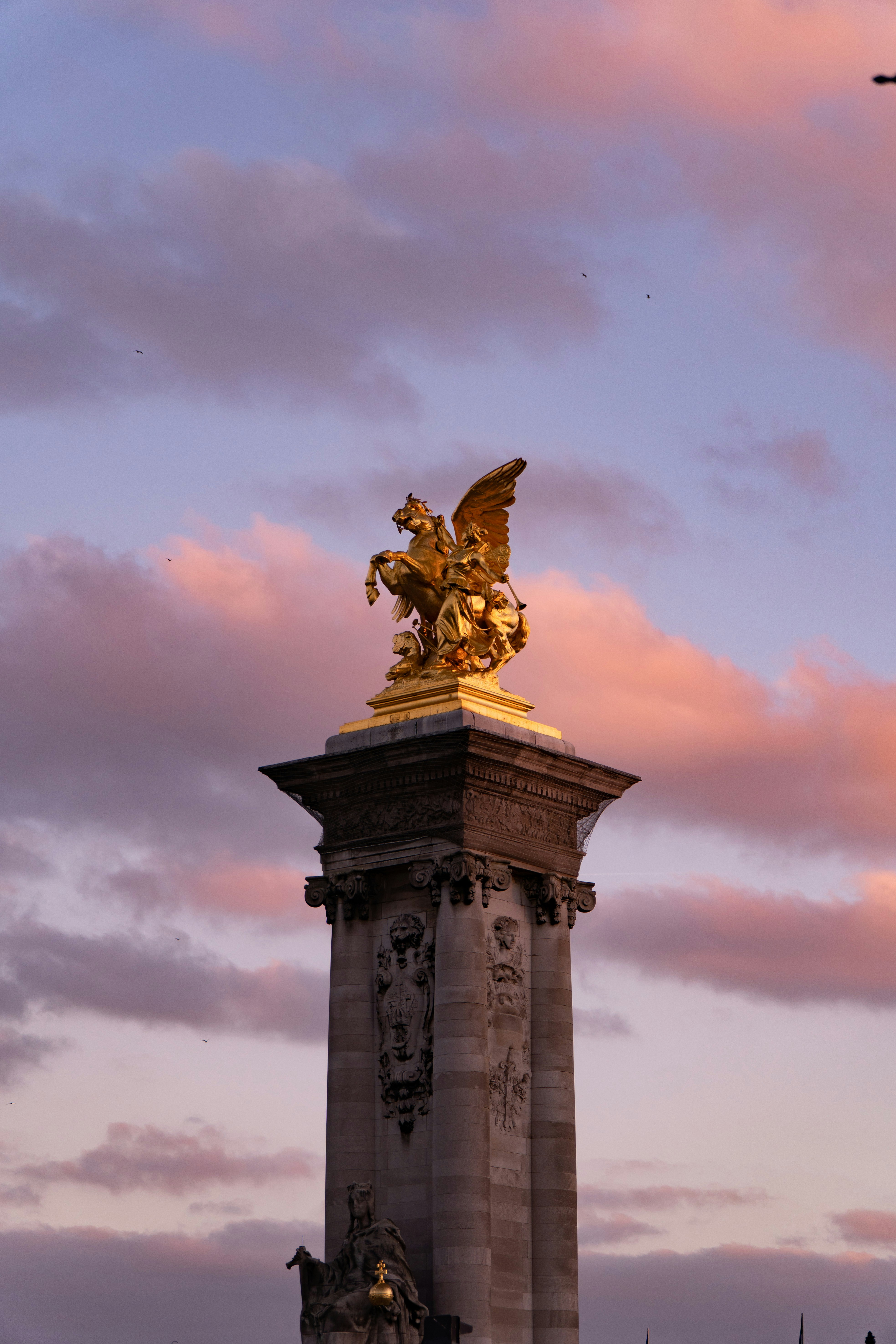 A statue of a winged bird on top of a building photo – Free Paris Image ...