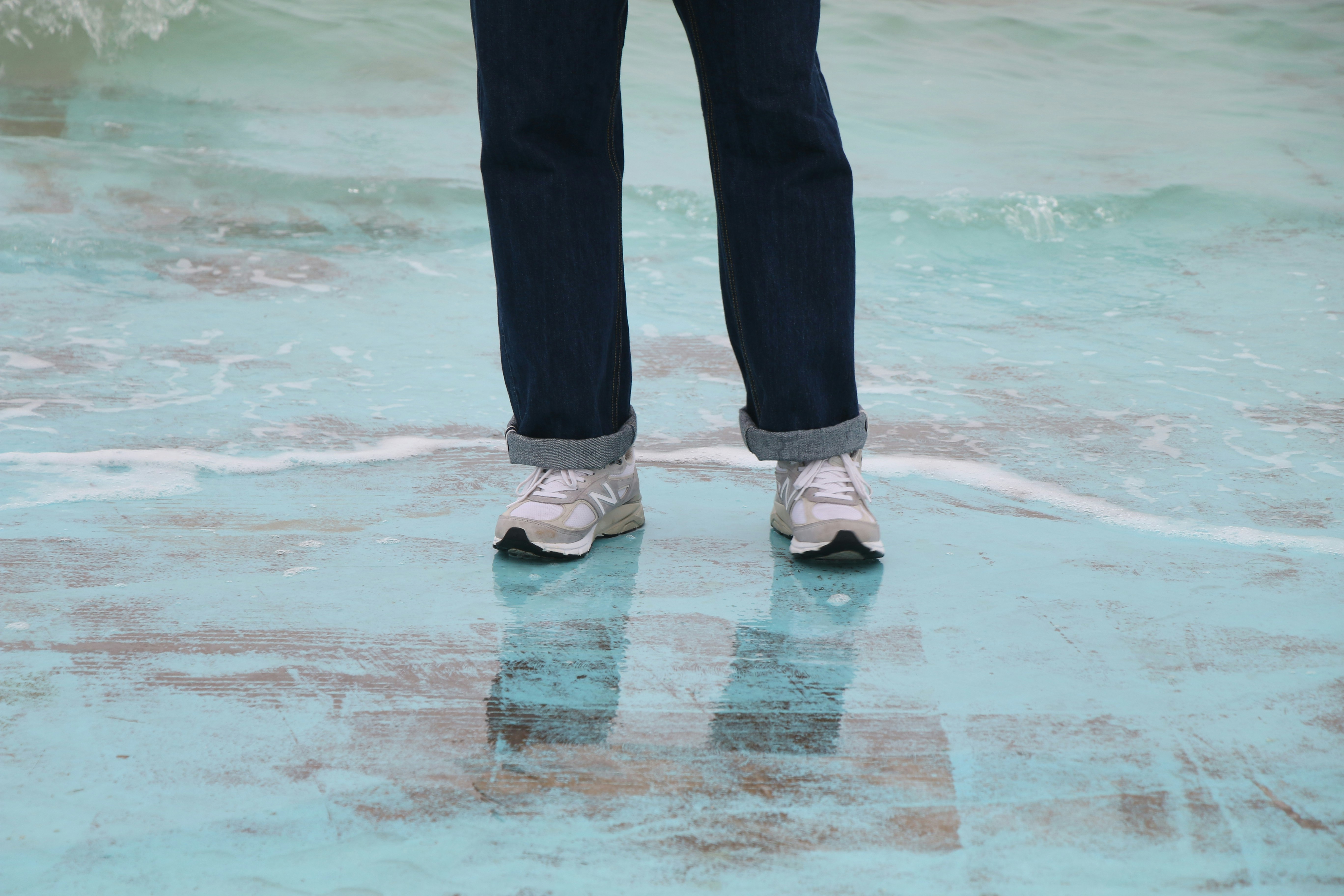 Turquoise Reflections: Sneakers Grounded on a Rain-Washed Surface