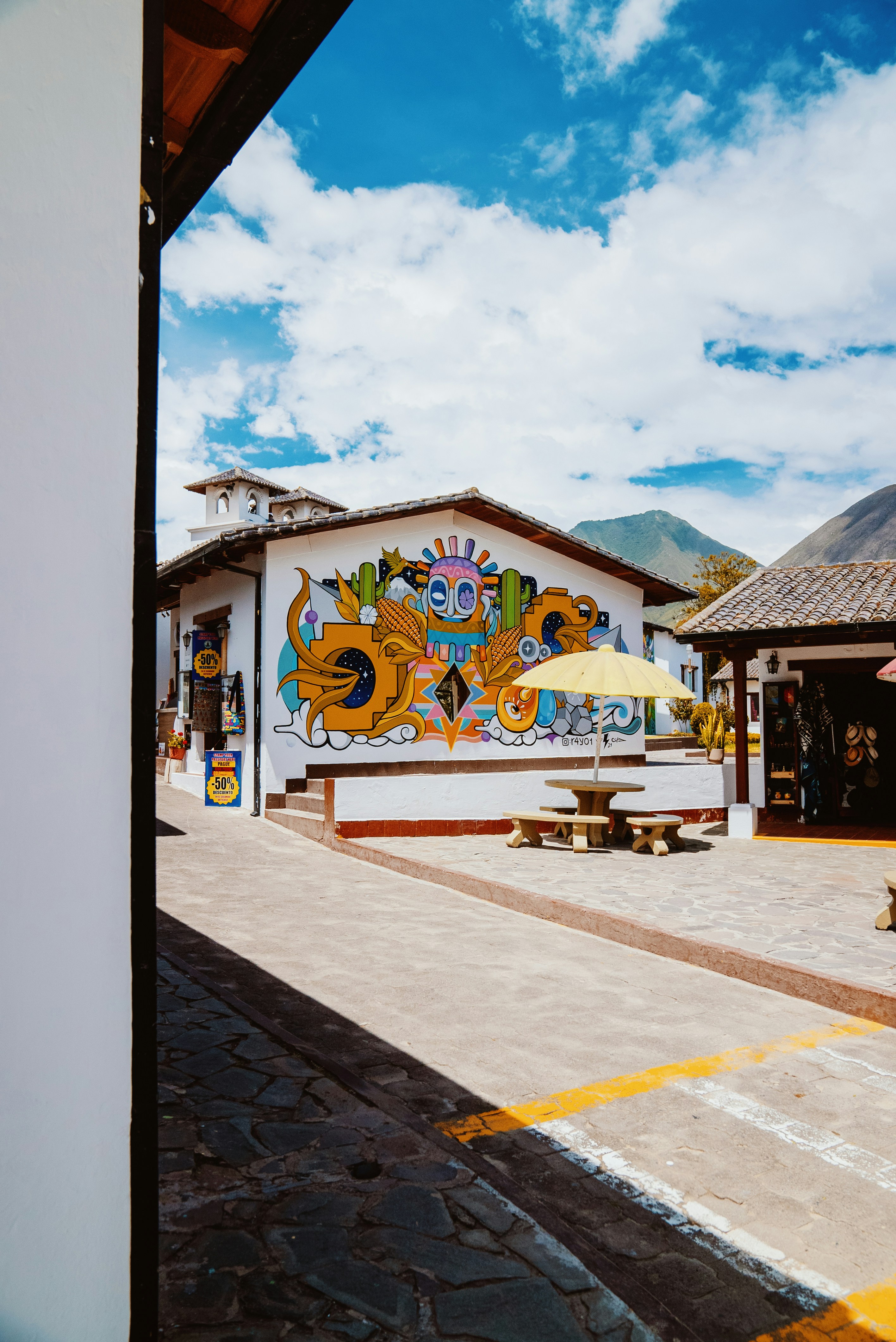 Vivid Mural Anchors a Sunlit Mountain Plaza