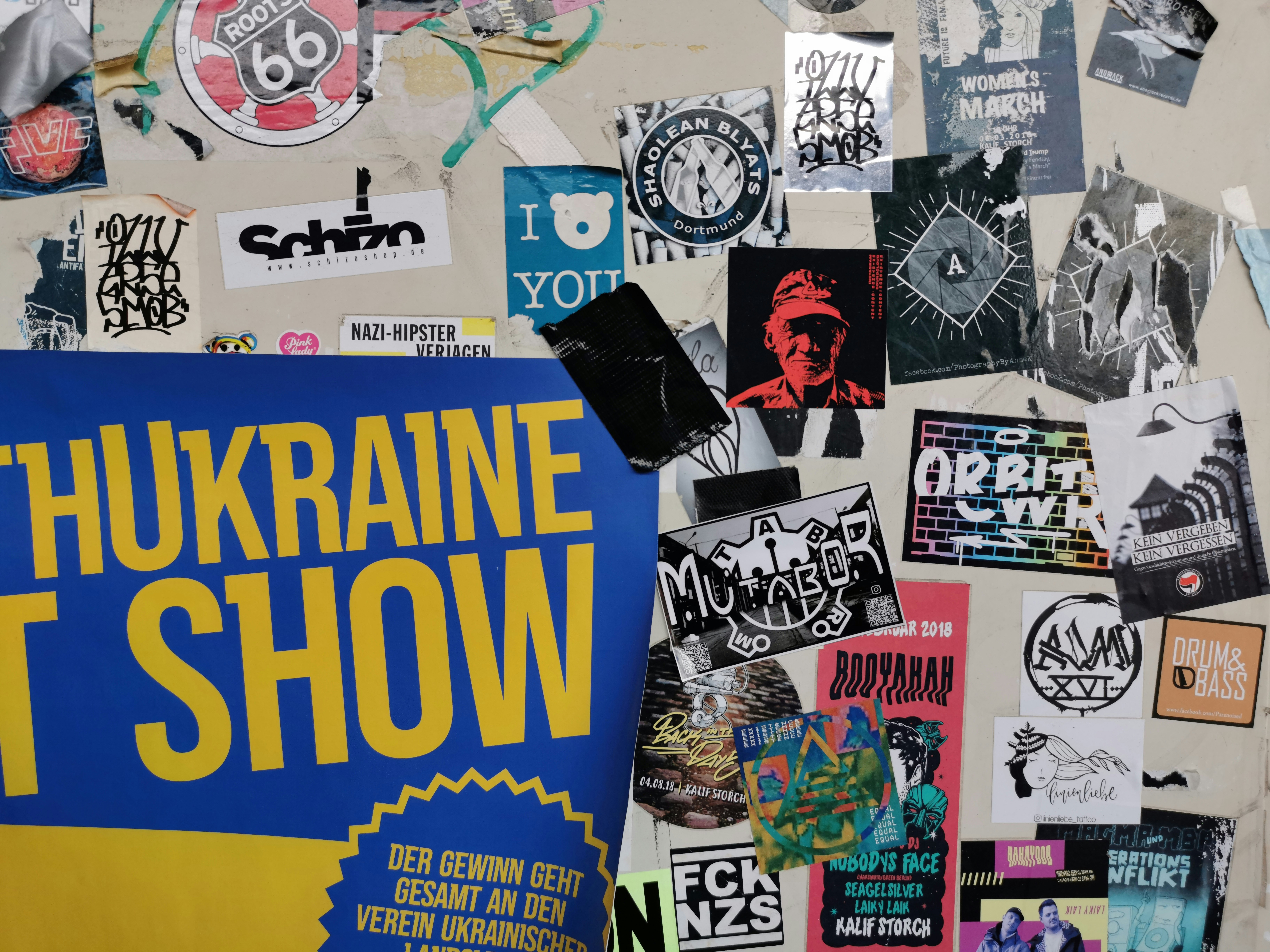 A wall covered in stickers and posters photo – Free Sticker Image on ...