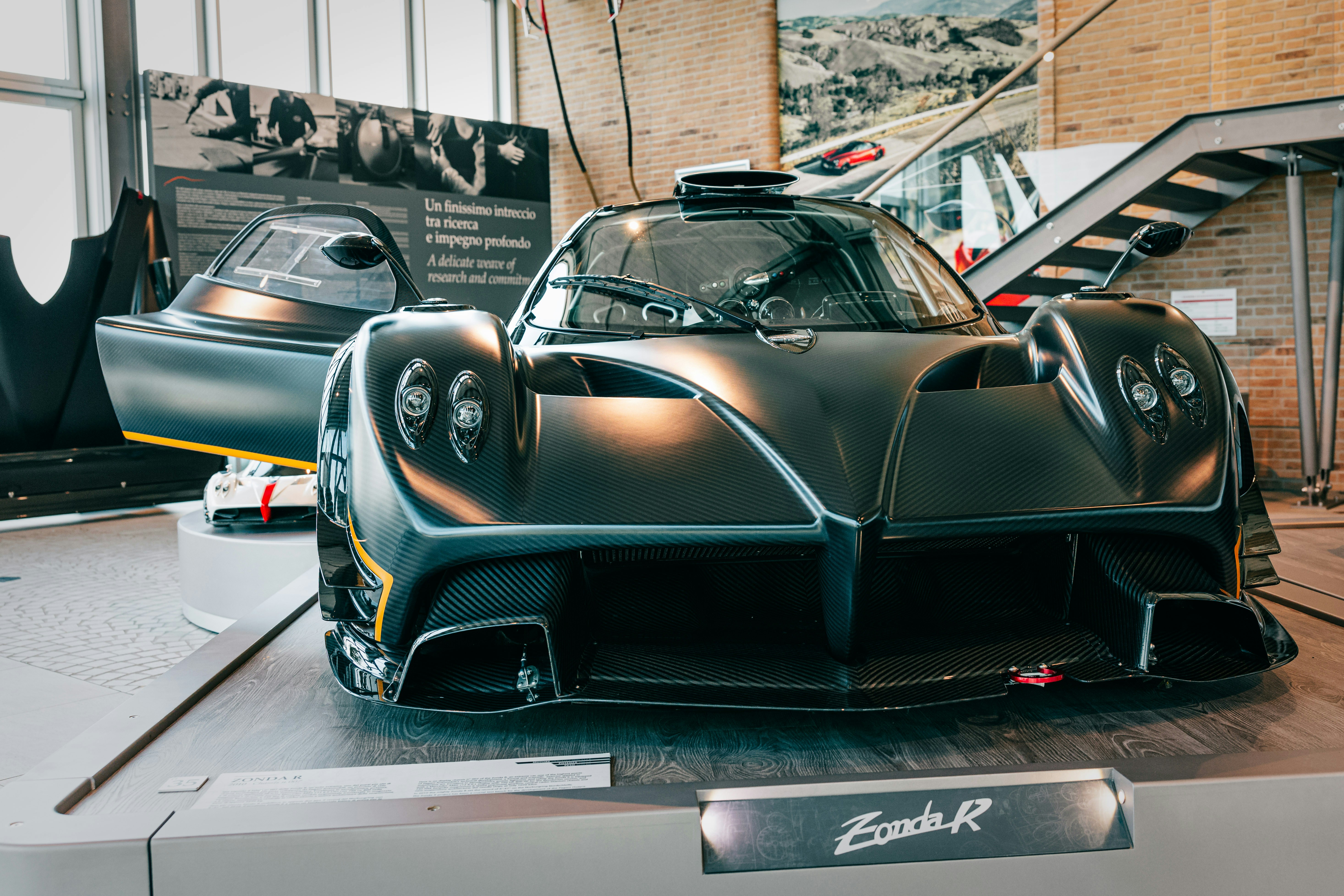Pagani Zonda displayed in a modern museum setting with industrial decor.