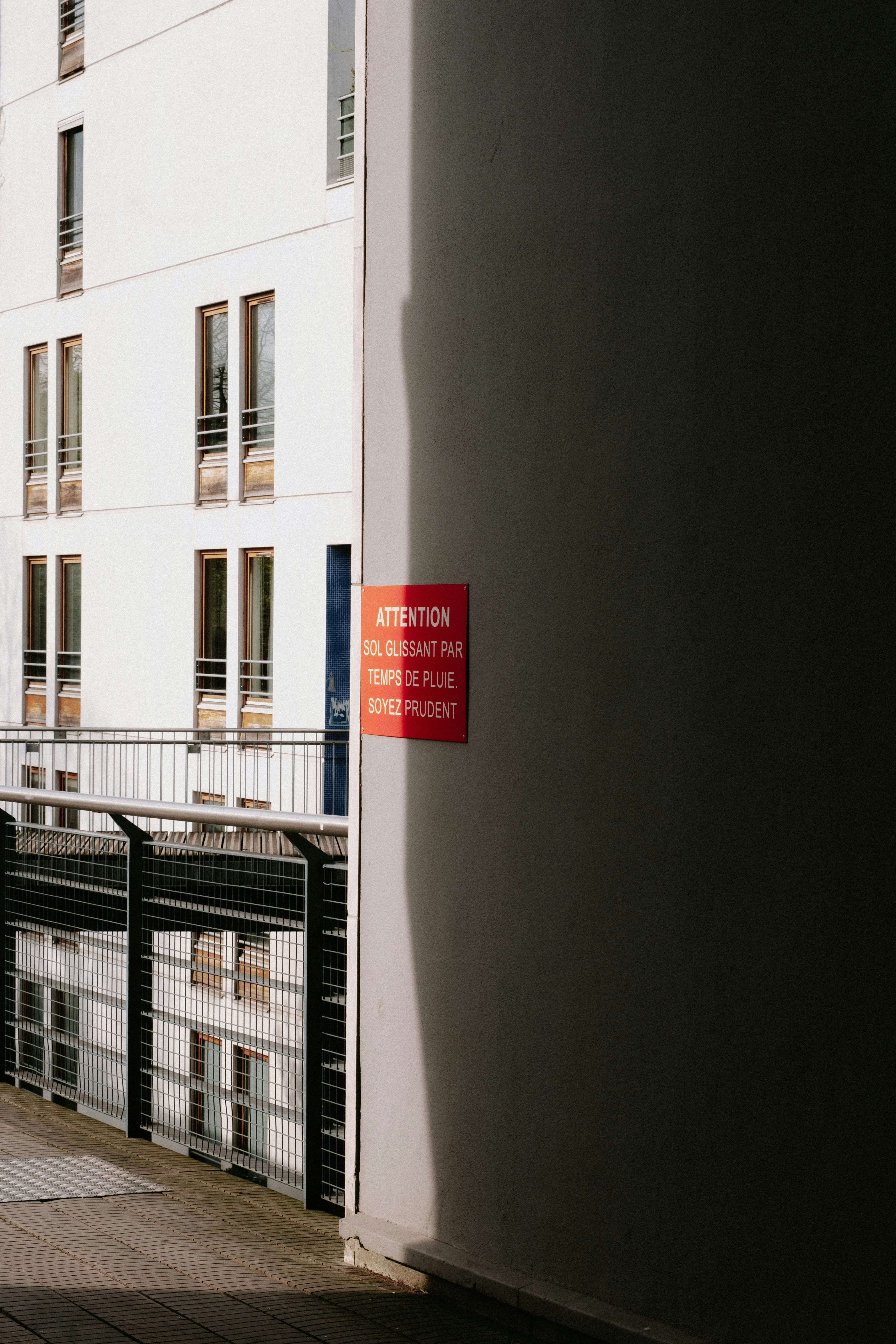 Red Sign, Quiet Facade: A Study in Light and Geometry
