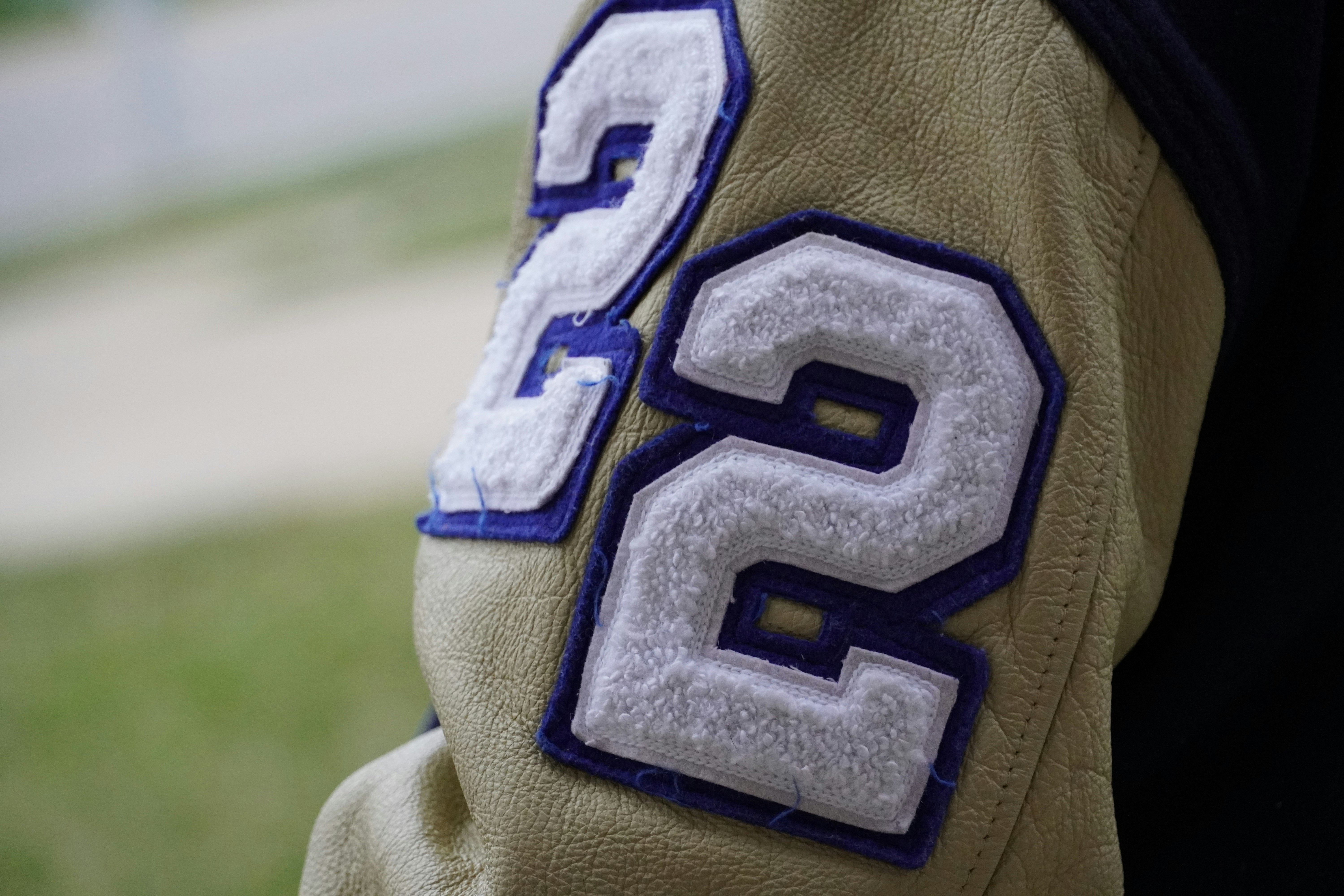 A close up of a person wearing a jacket with numbers on it photo – Free ...