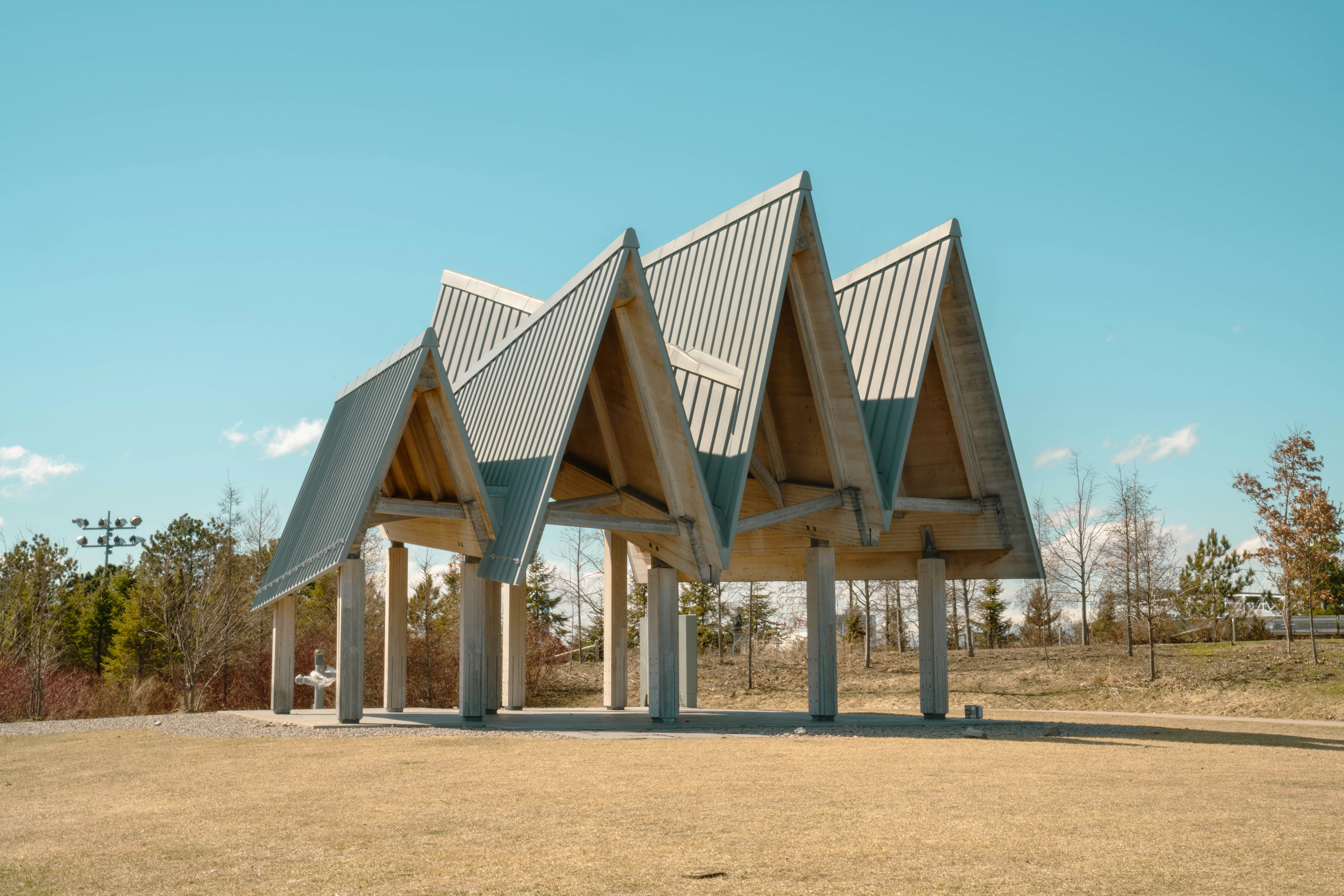 A group of wooden structures sitting in a field photo – Free Shelter ...