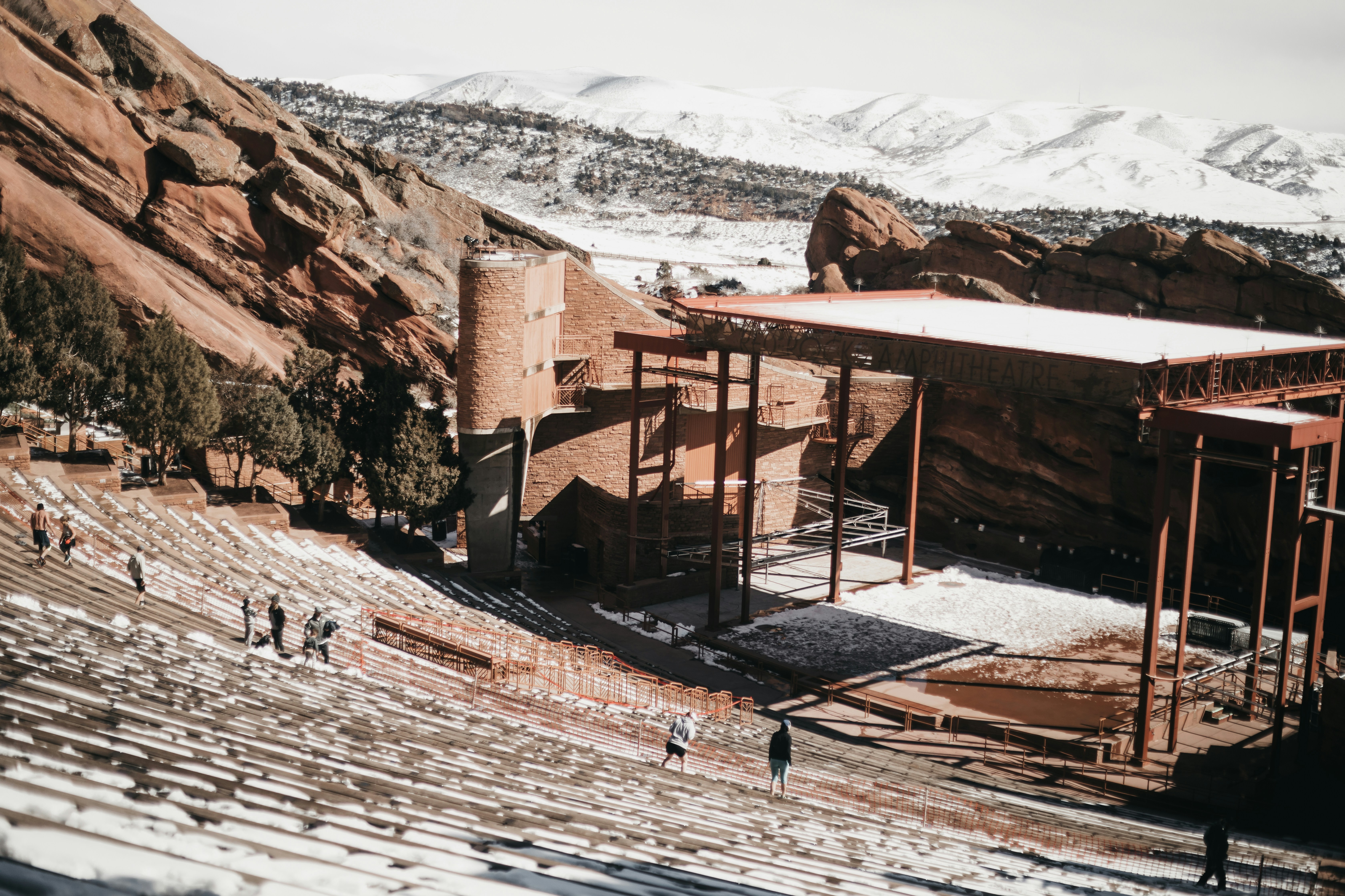 Snow-covered amphitheater nestled among rocky formations, showcasing a blend of natural beauty and human architecture.