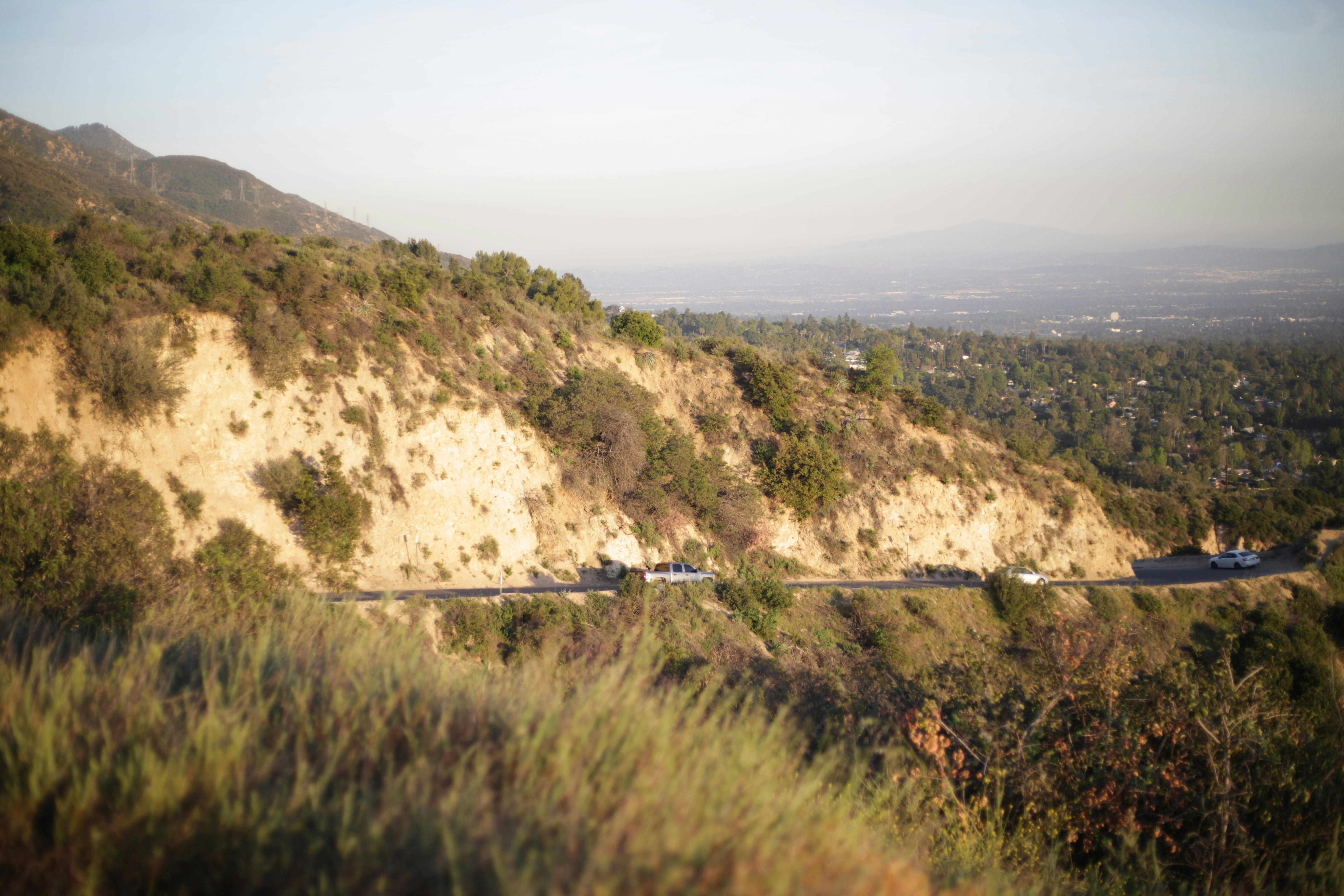A view of a mountain with a road going up the side of it photo – Free ...