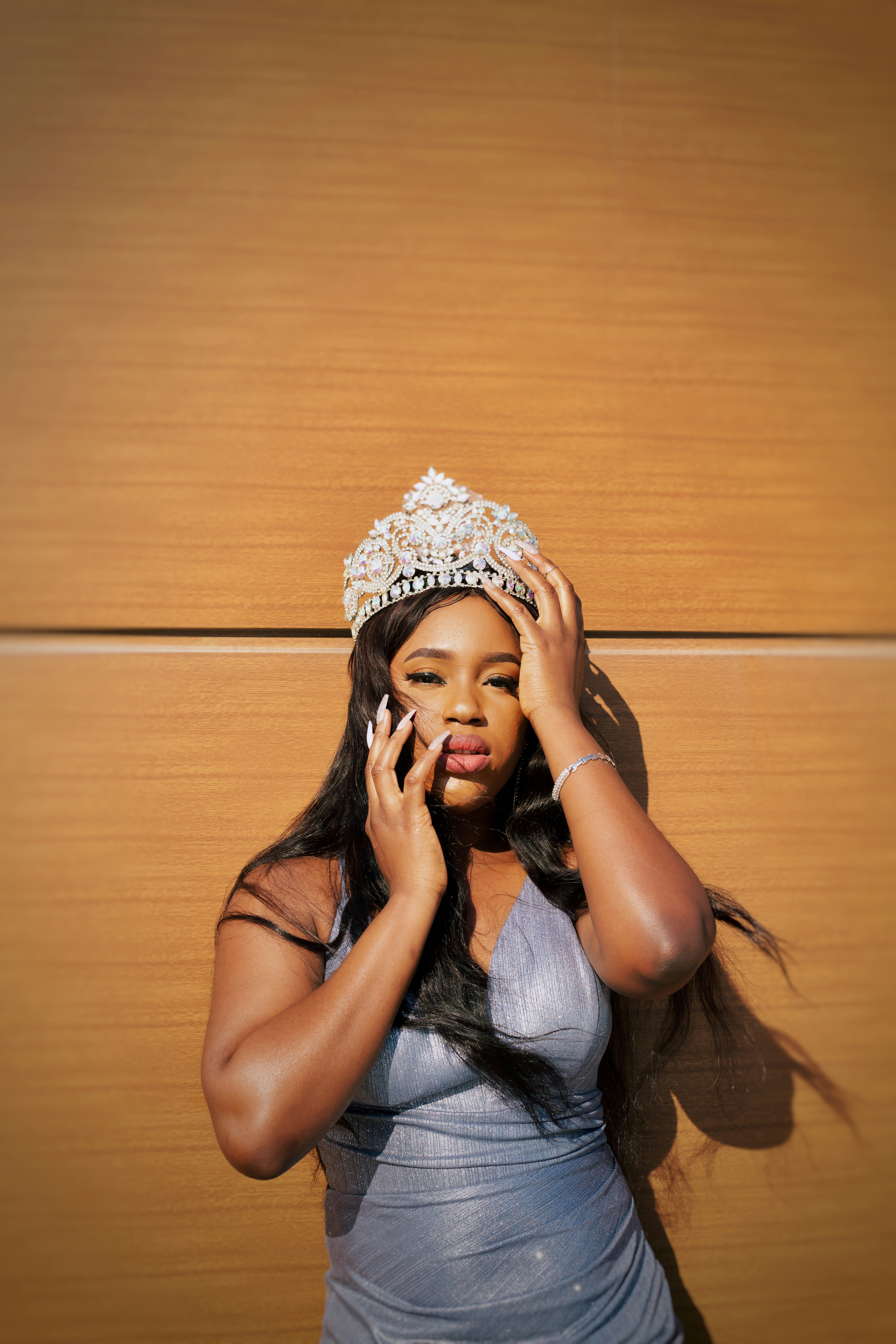 A woman wearing a tiara talking on a cell phone photo – Free Person ...