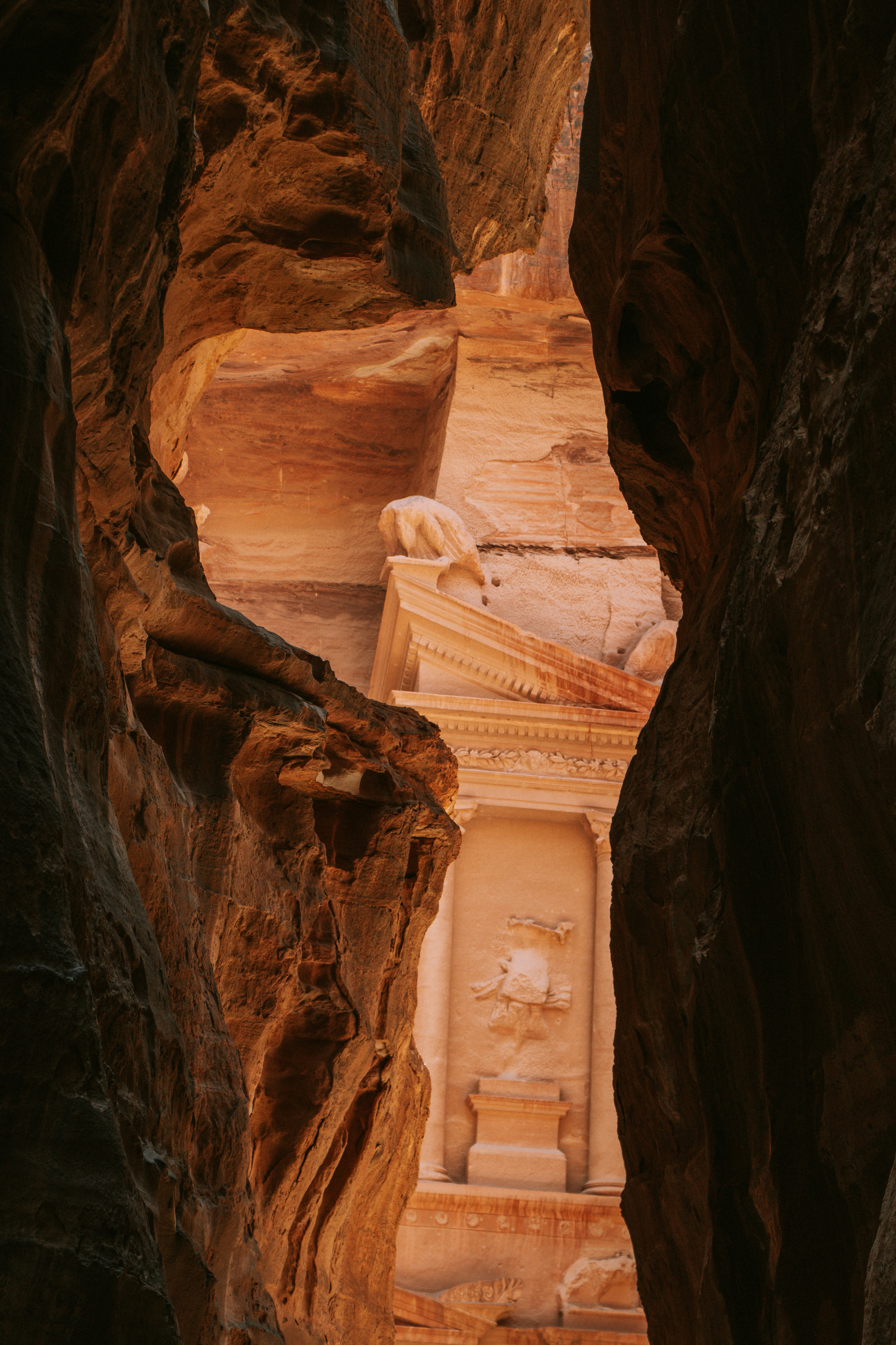 A narrow canyon with a statue in the middle of it photo – Free Jordan ...