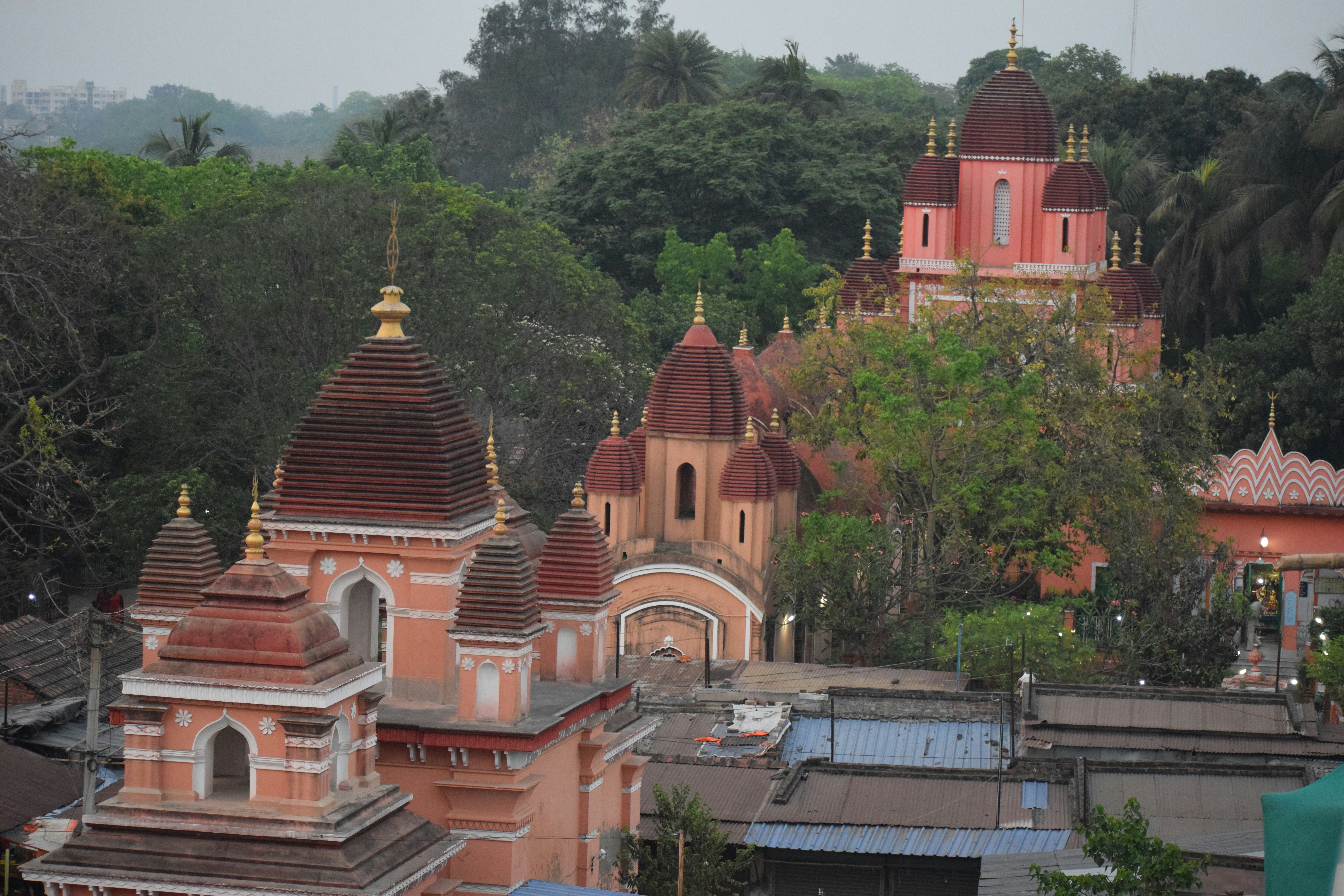 Intricate temple architecture surrounded by lush greenery, showcasing a blend of spirituality and nature.