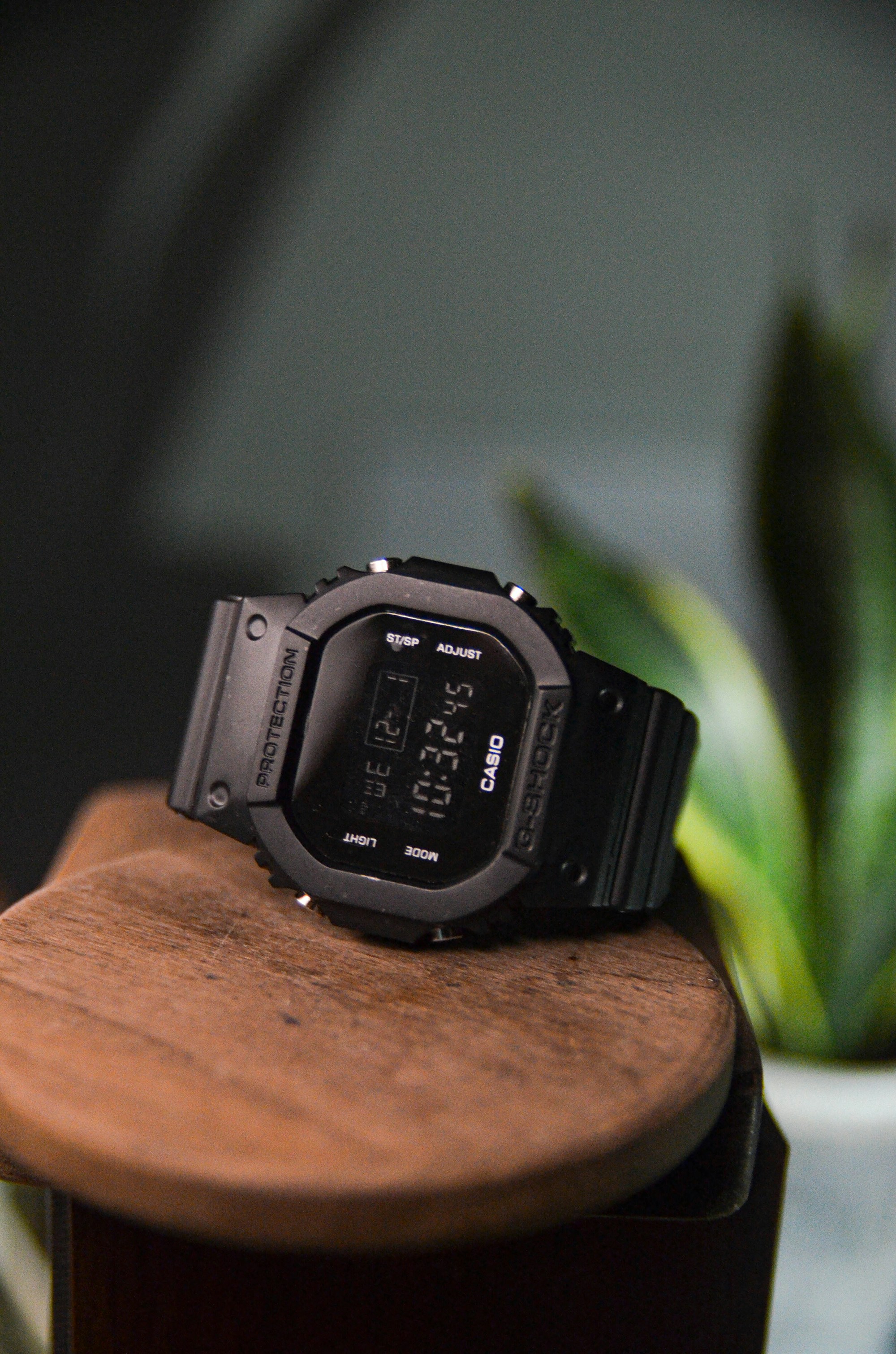 A watch sitting on top of a wooden table photo – Free Wristwatch Image ...