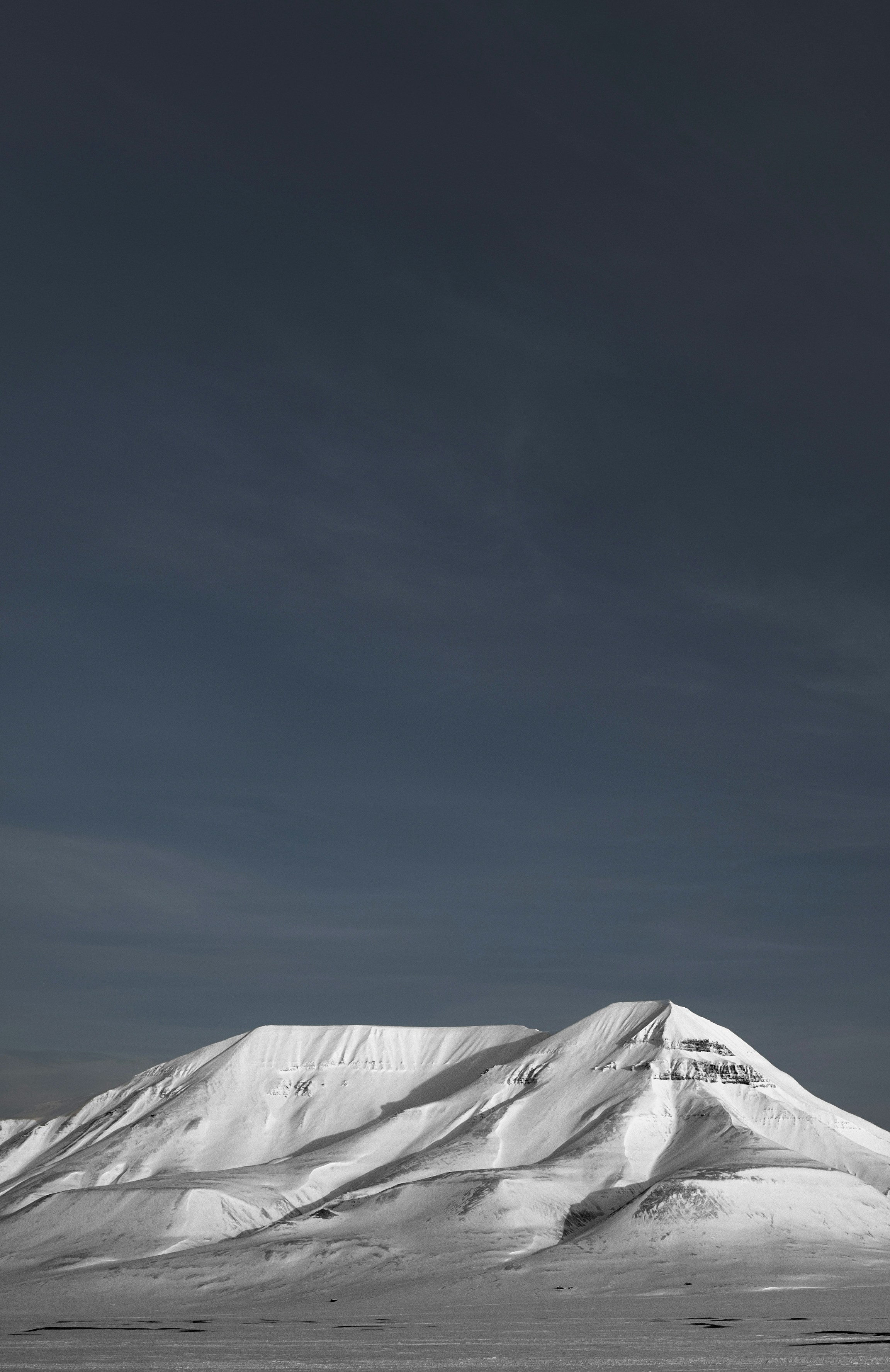 Foto Una montaña cubierta de nieve bajo un cielo nublado – Imagen ...