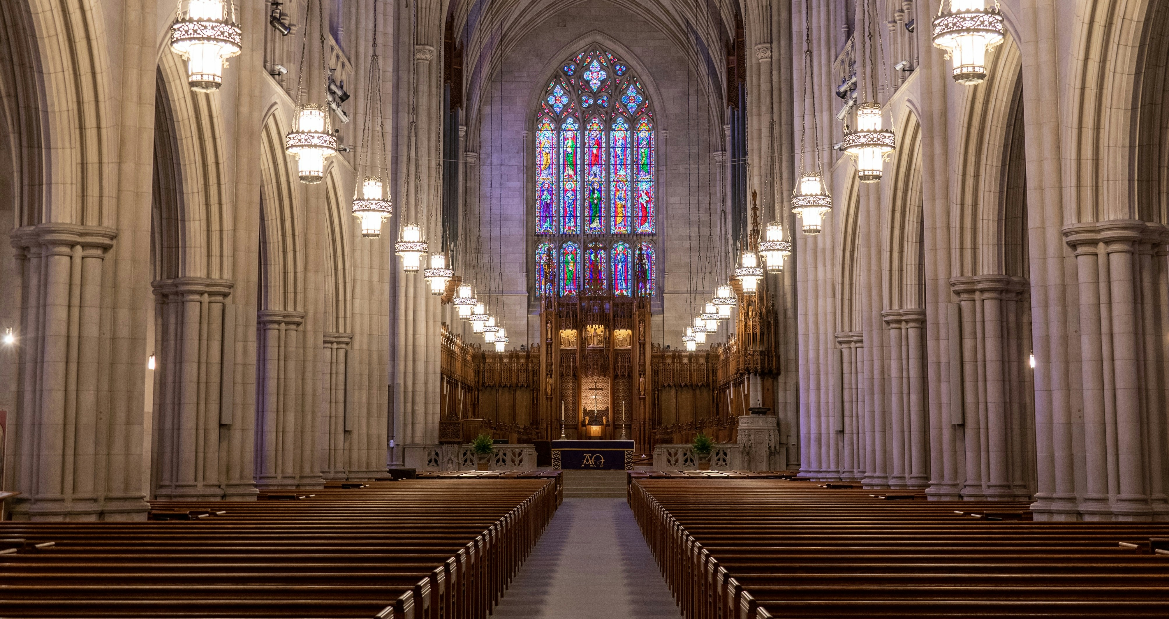 A cathedral with pews and stained glass windows photo – Free Duke ...