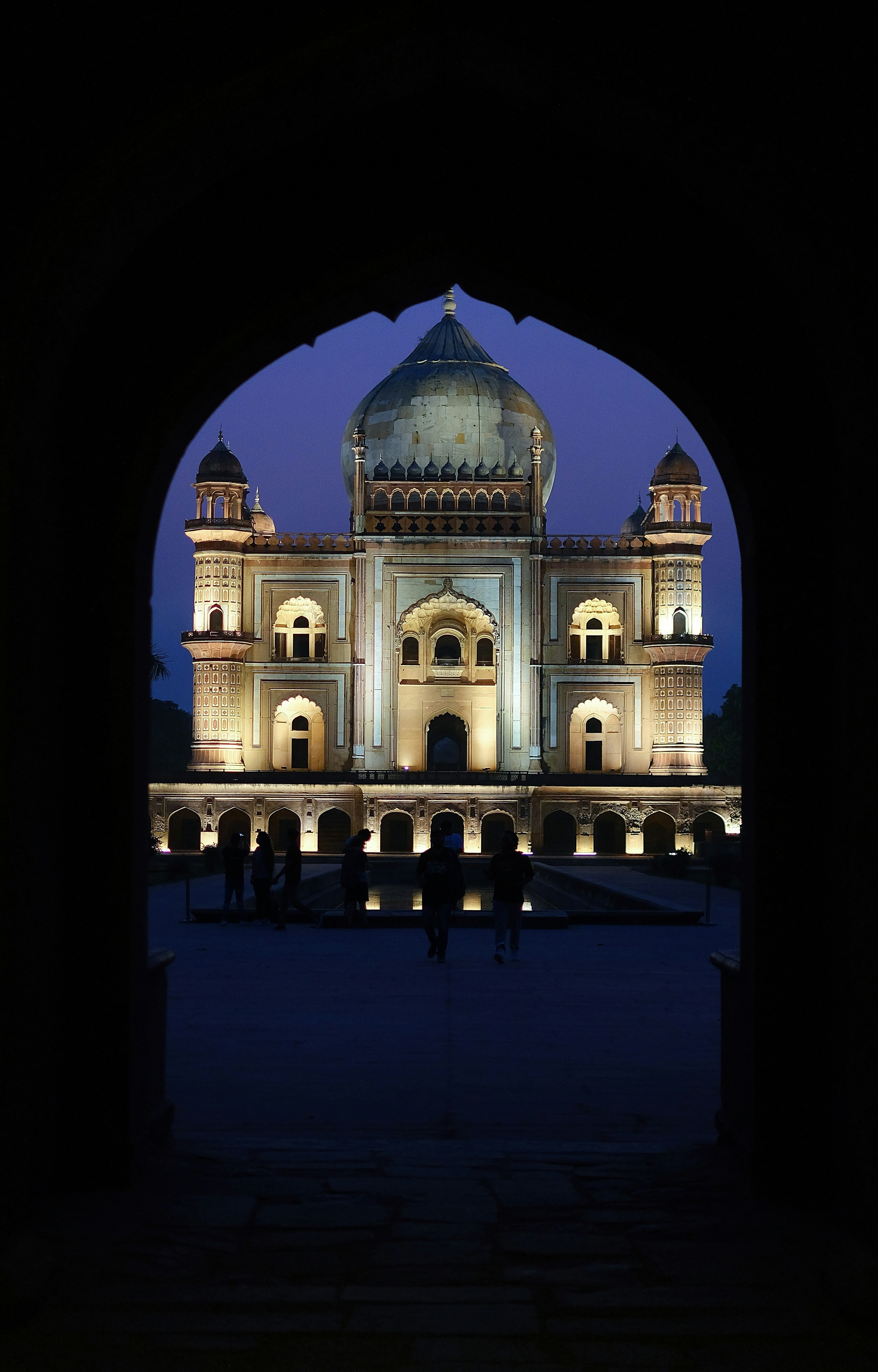 Illuminated Taj-like Facade Framed by an Arch at Dusk