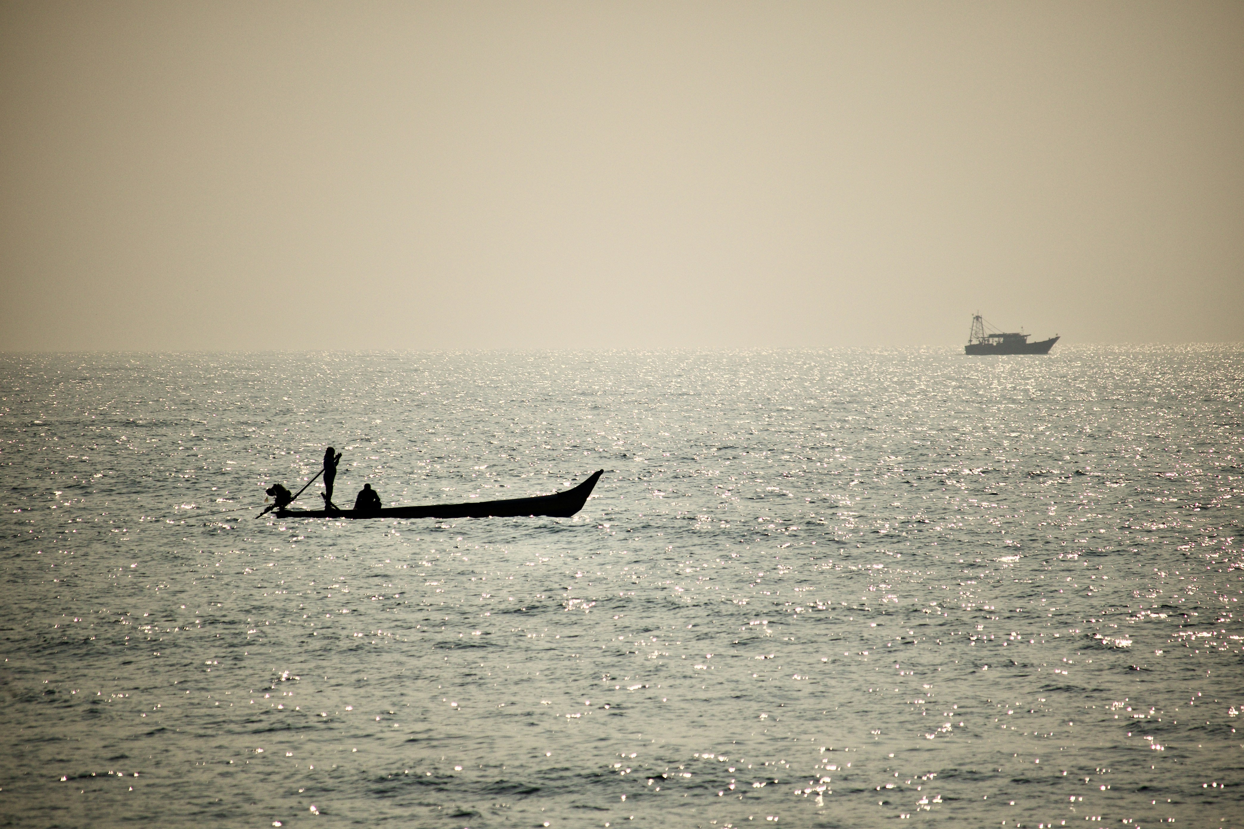 A silhouette of fishermen fishing in the Bay of Bengal ocean at Pondicherry, Puducherry, India.