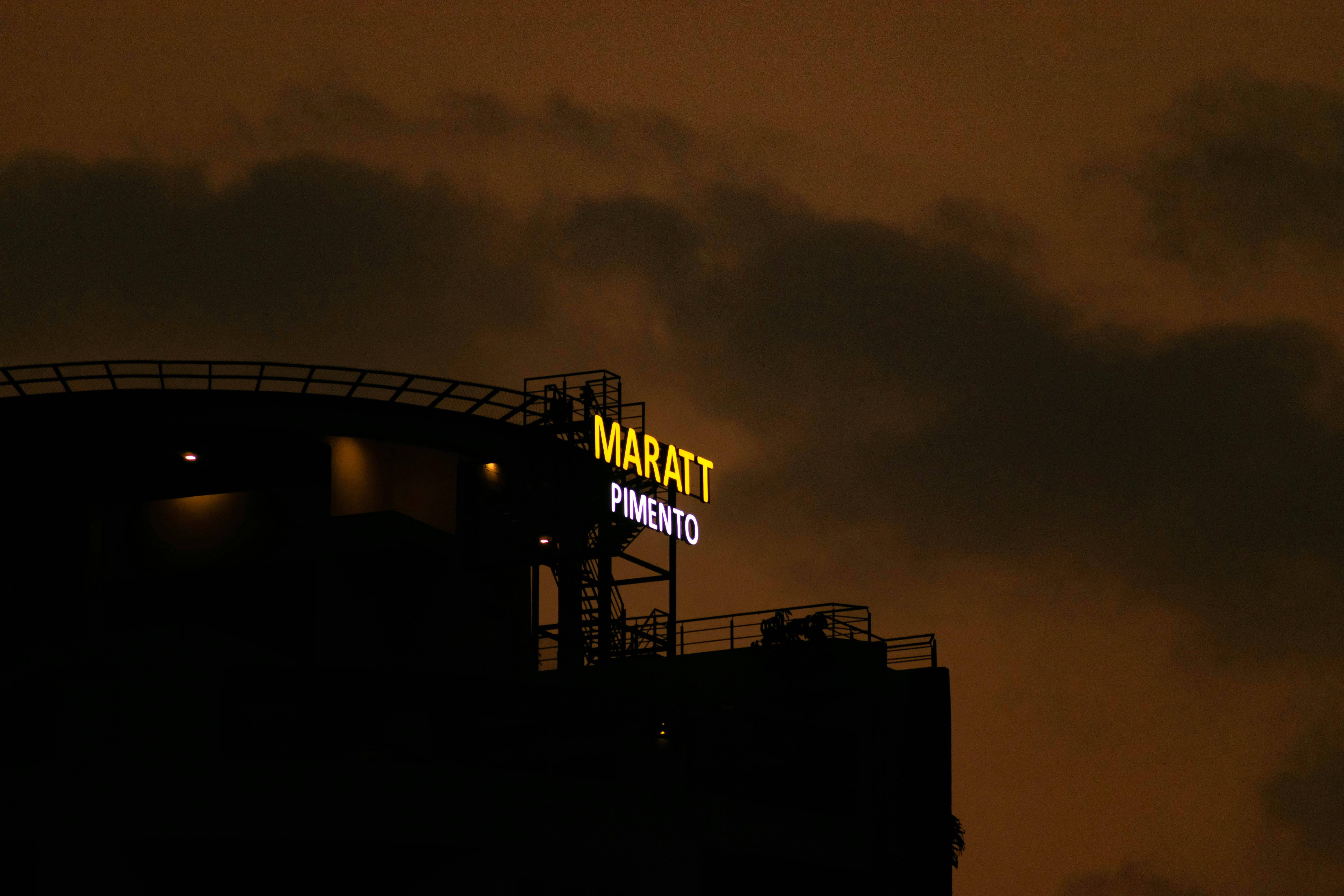 Neon Sign Over a Dusk-Shadowed Factory: Maratt Pimento