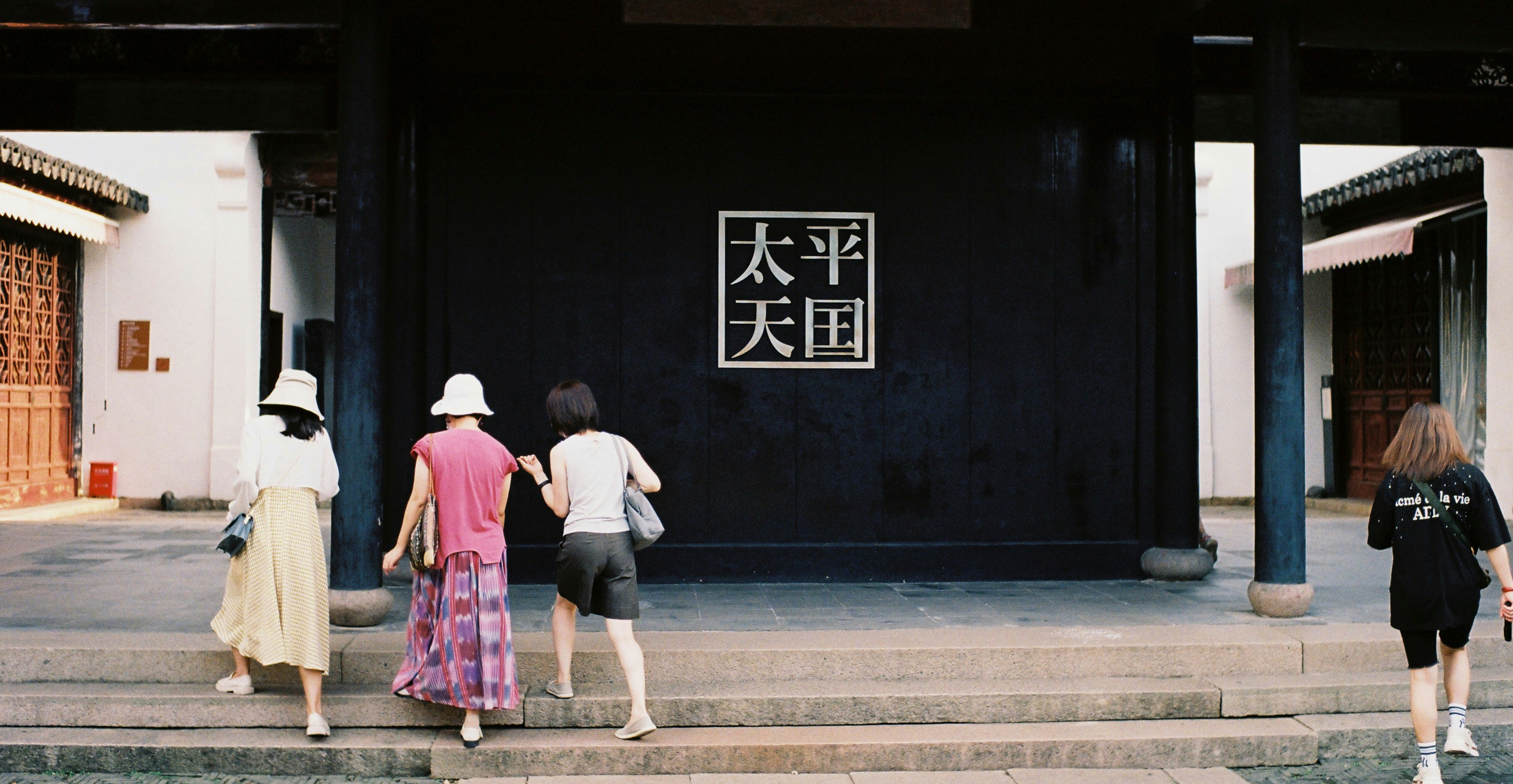 A group of people walking up some steps photo – Free Film photography ...