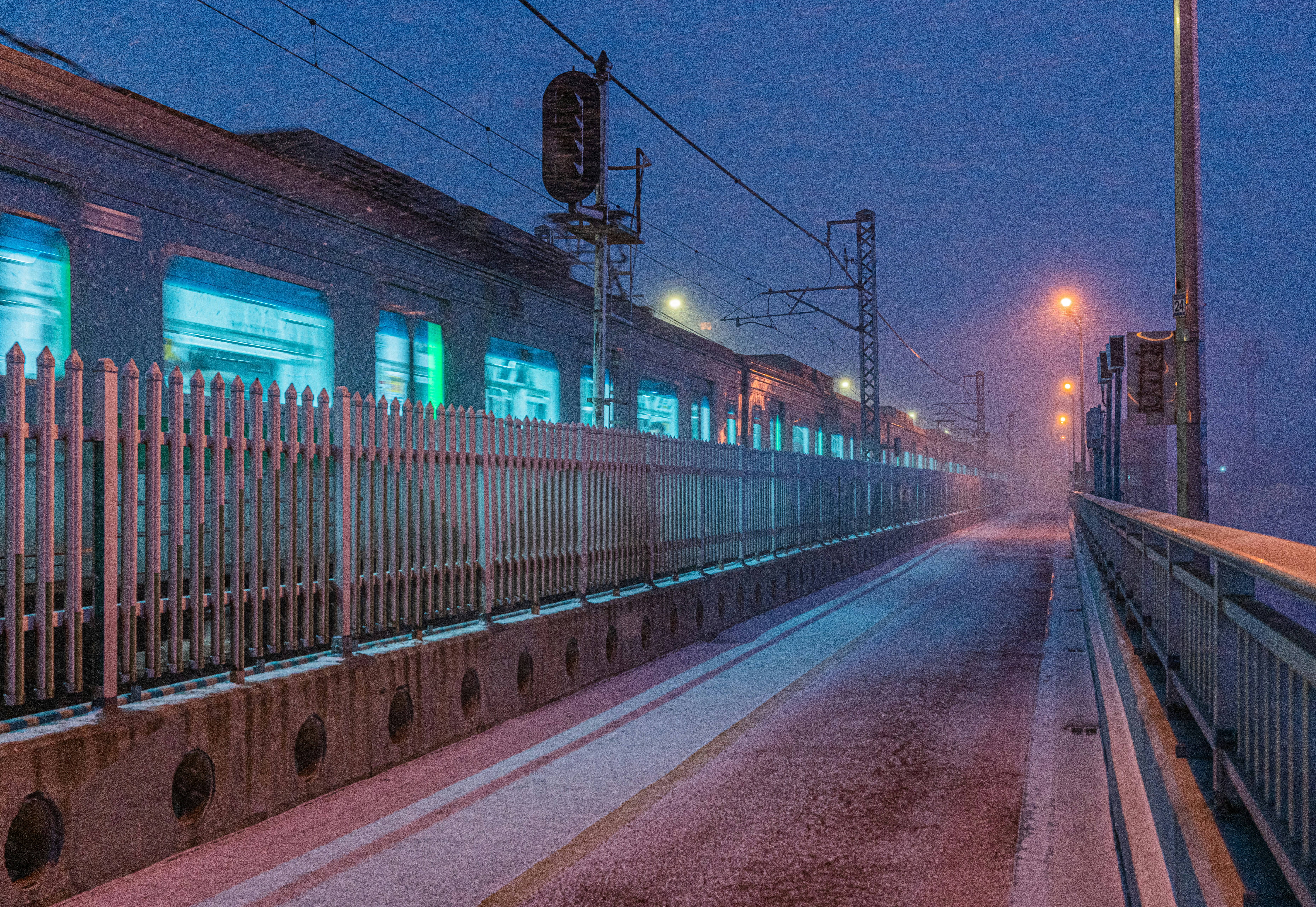 Blue-Glowed Carriages on a Snowbound Platform at Dusk