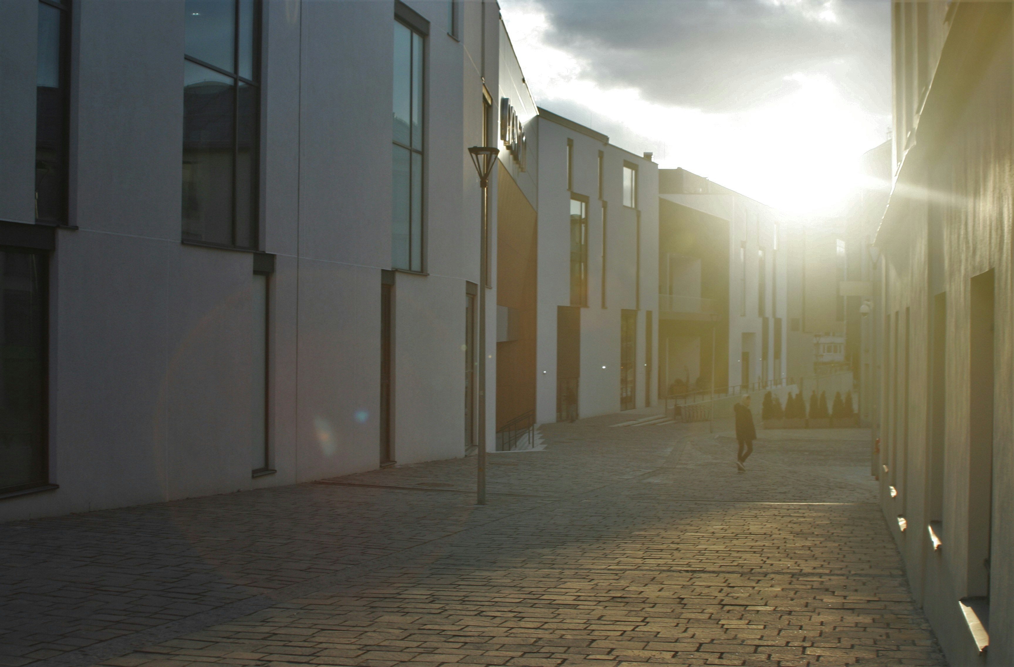 Sunlit Gauntlet: A Quiet Cobblestone Alley at Golden Hour