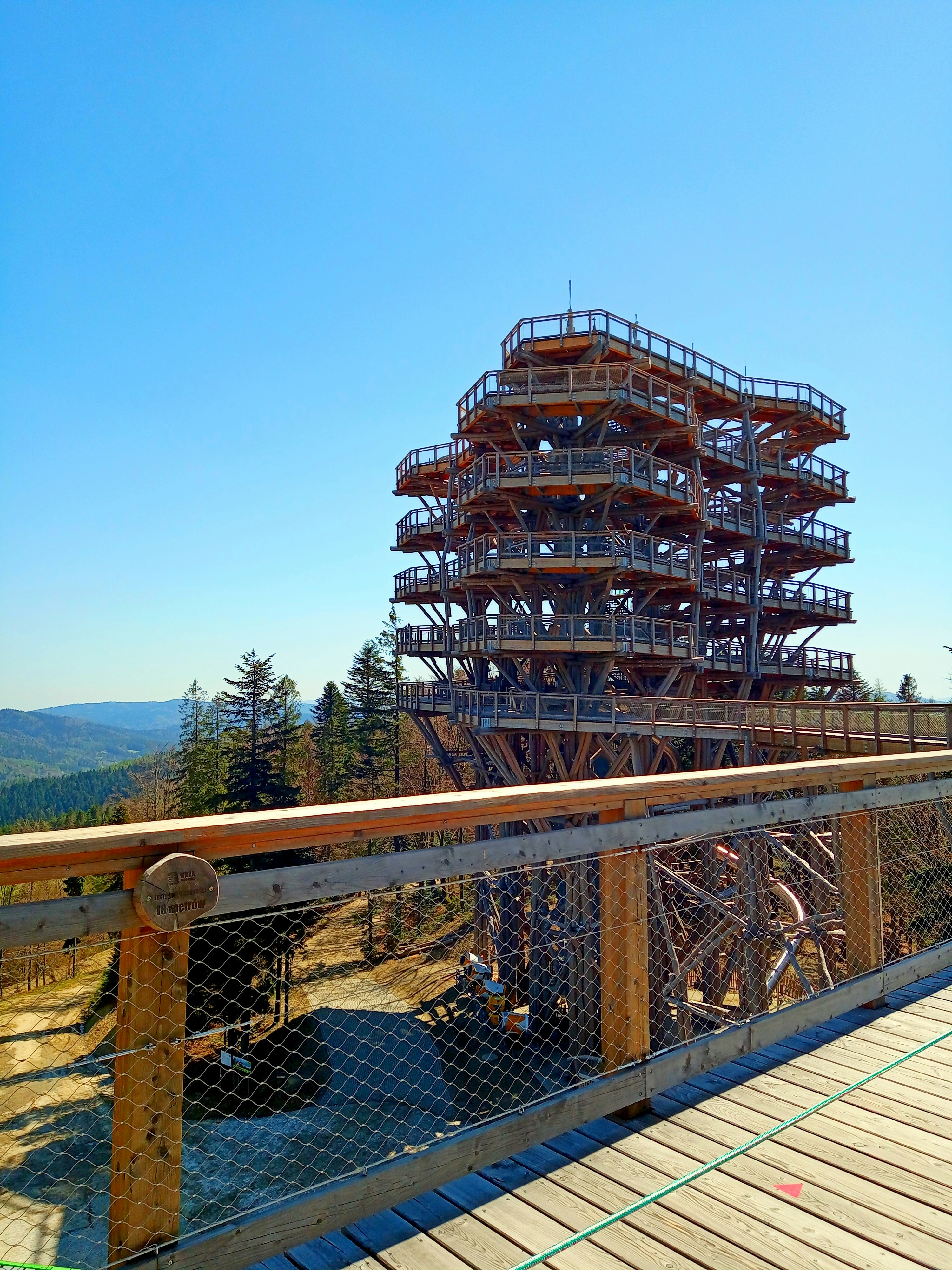 a tall wooden structure sitting on top of a wooden deck
