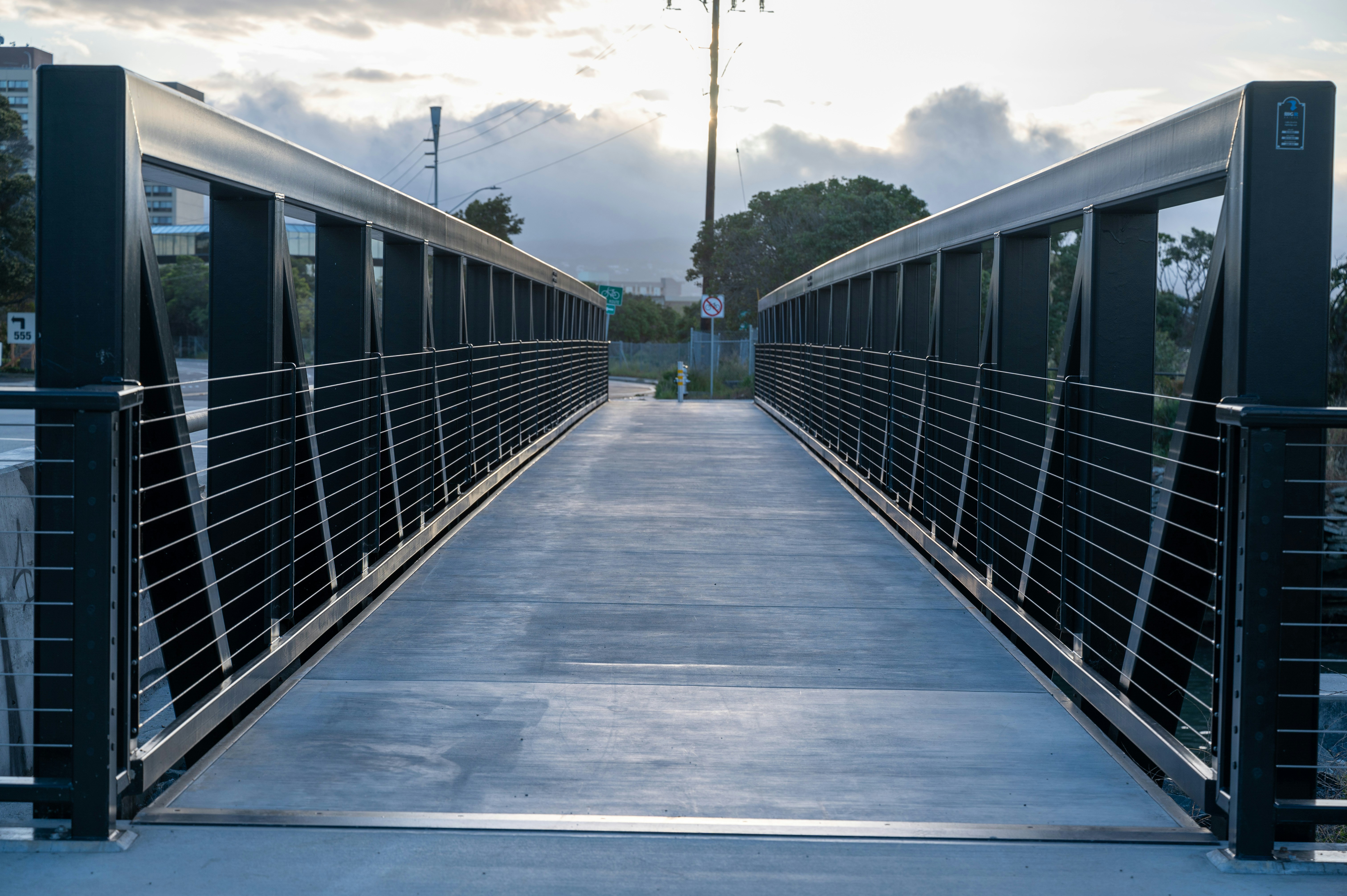 A bridge that has a metal railing on it photo – Free Grey Image on Unsplash