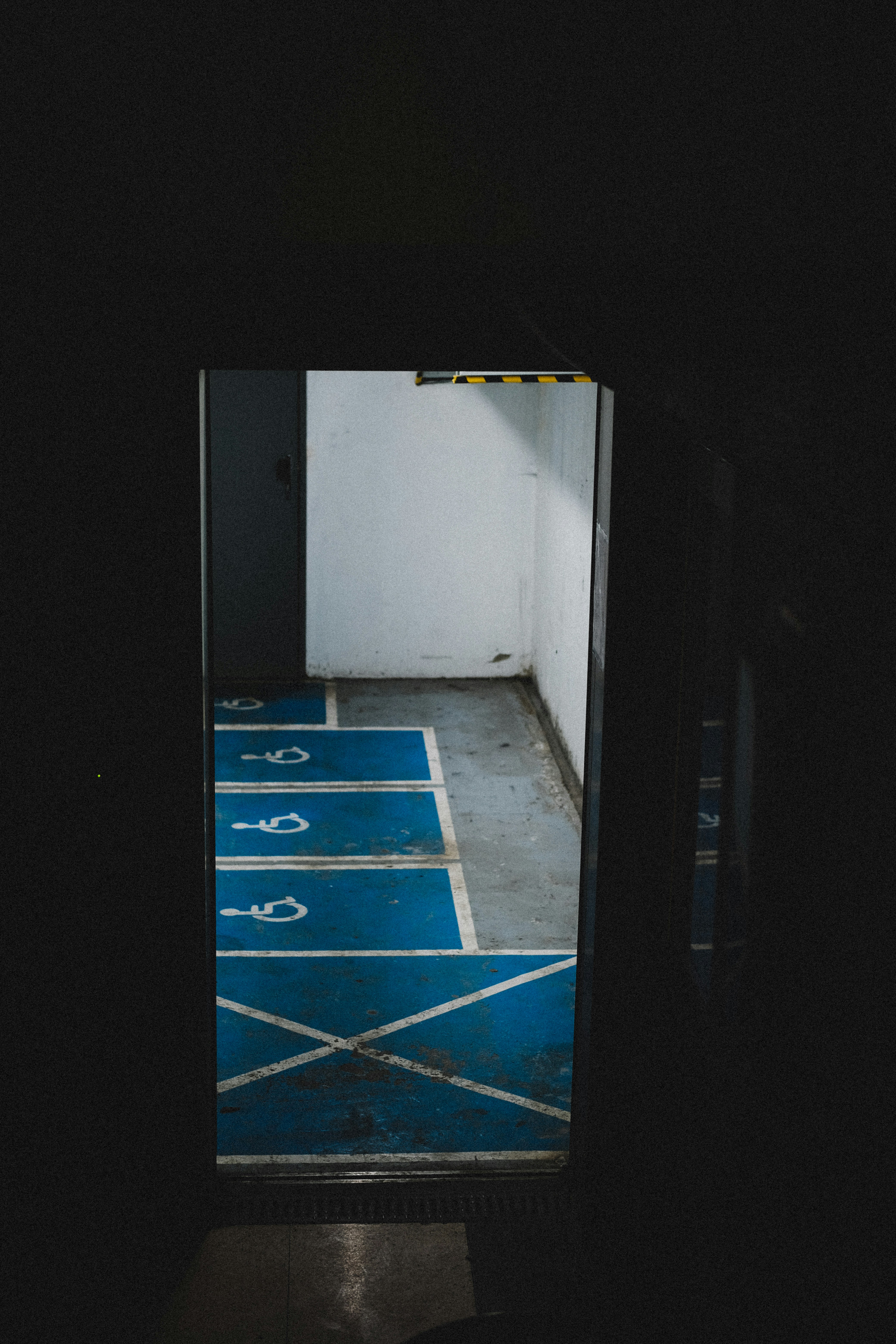 an empty room with a blue floor and white walls