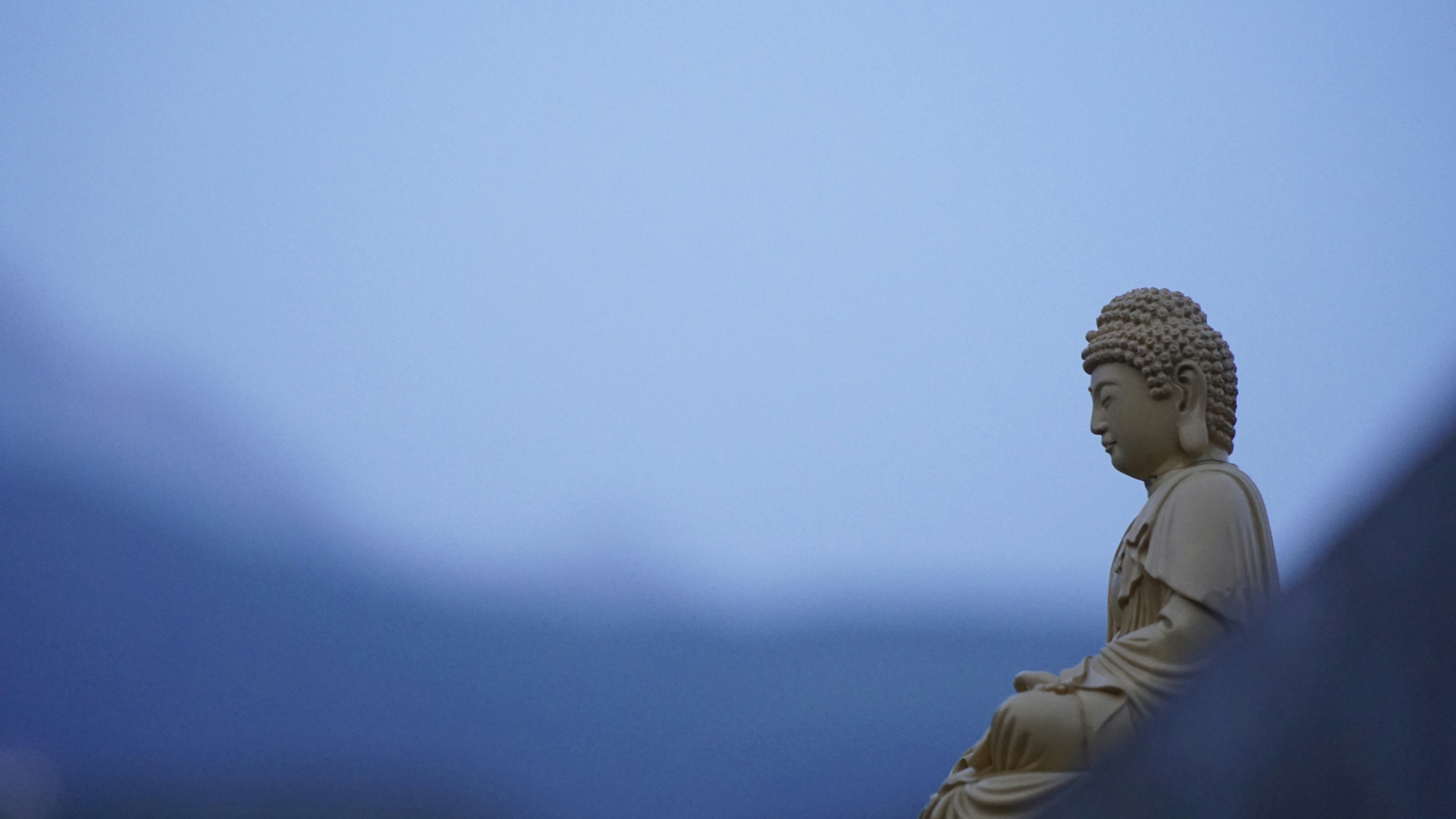 Blue Silence: Buddha in Soft Focus at the Edge of Light