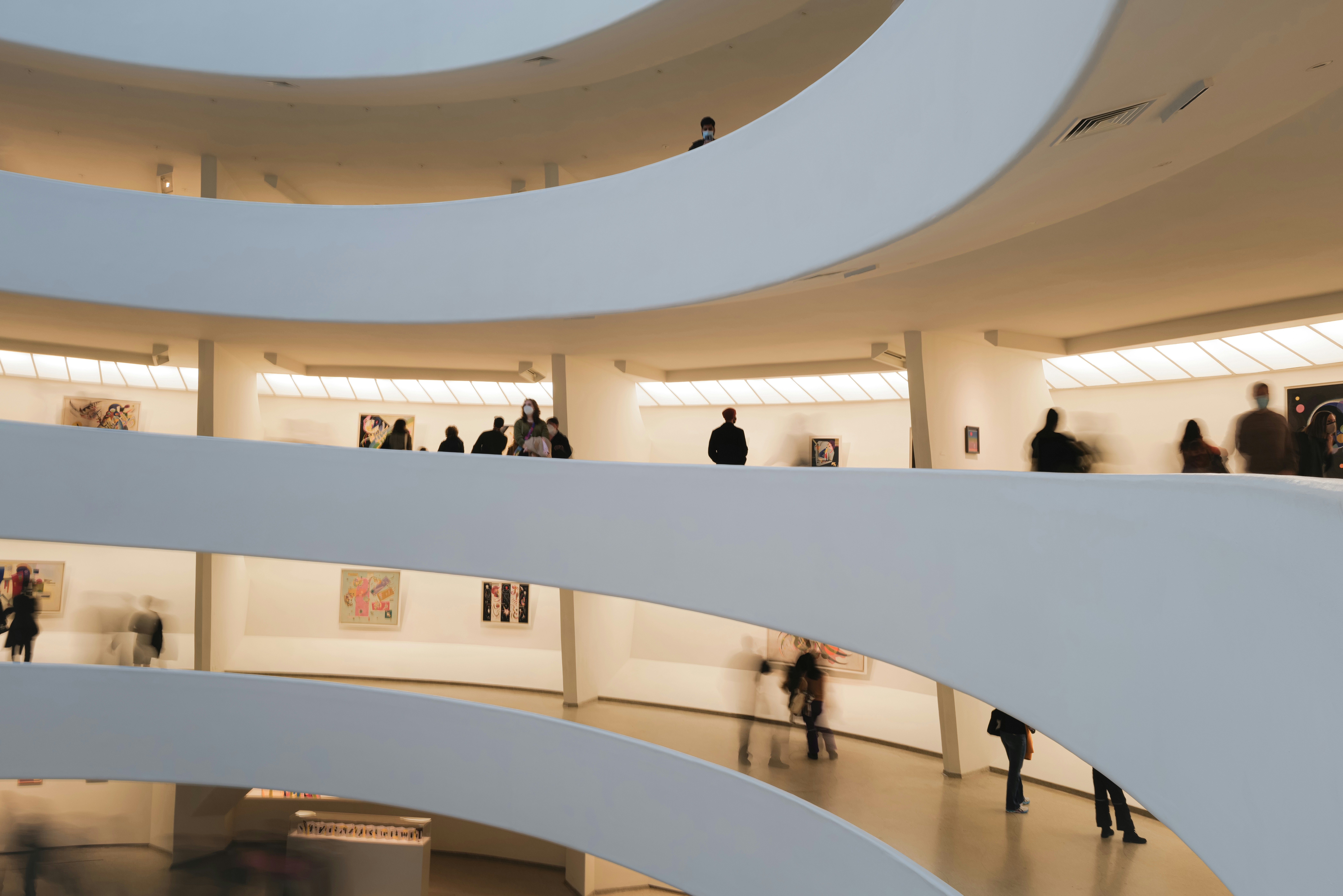 A group of people walking around a museum photo – Free Person Image on ...