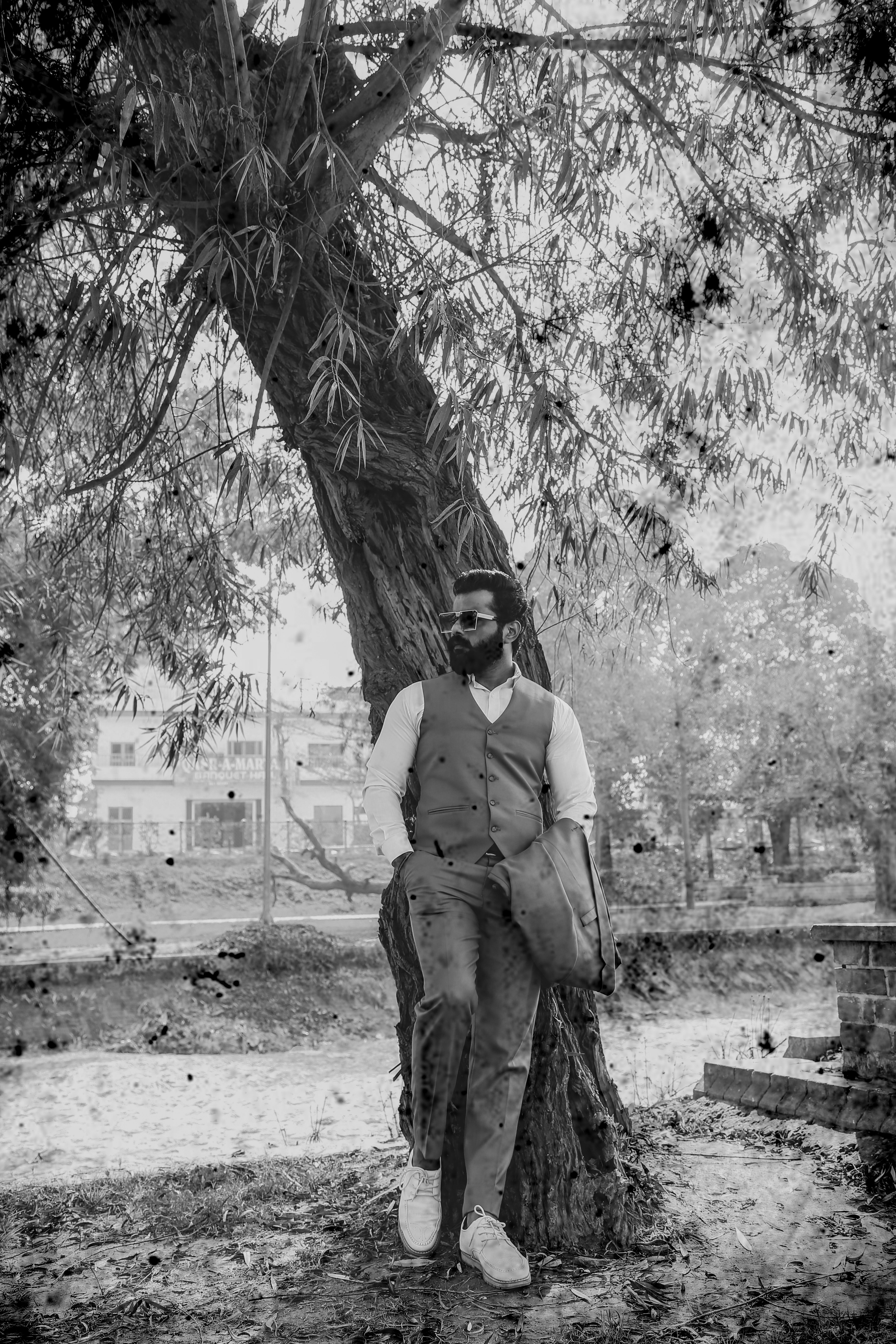 A man standing next to a tree in a park photo – Free Outdoors Image on ...