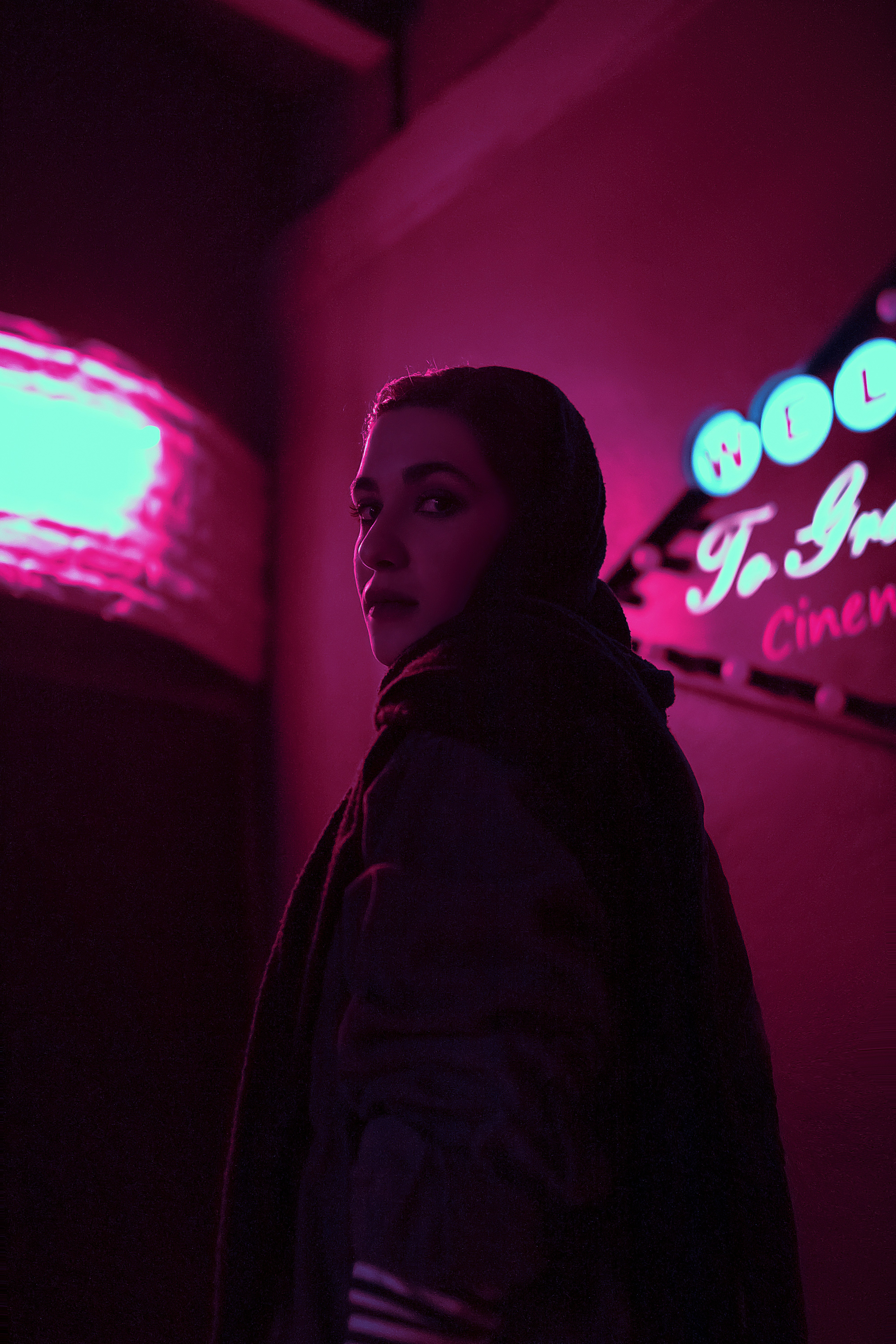 A woman standing in front of a neon sign photo – Free Tehran Image on ...