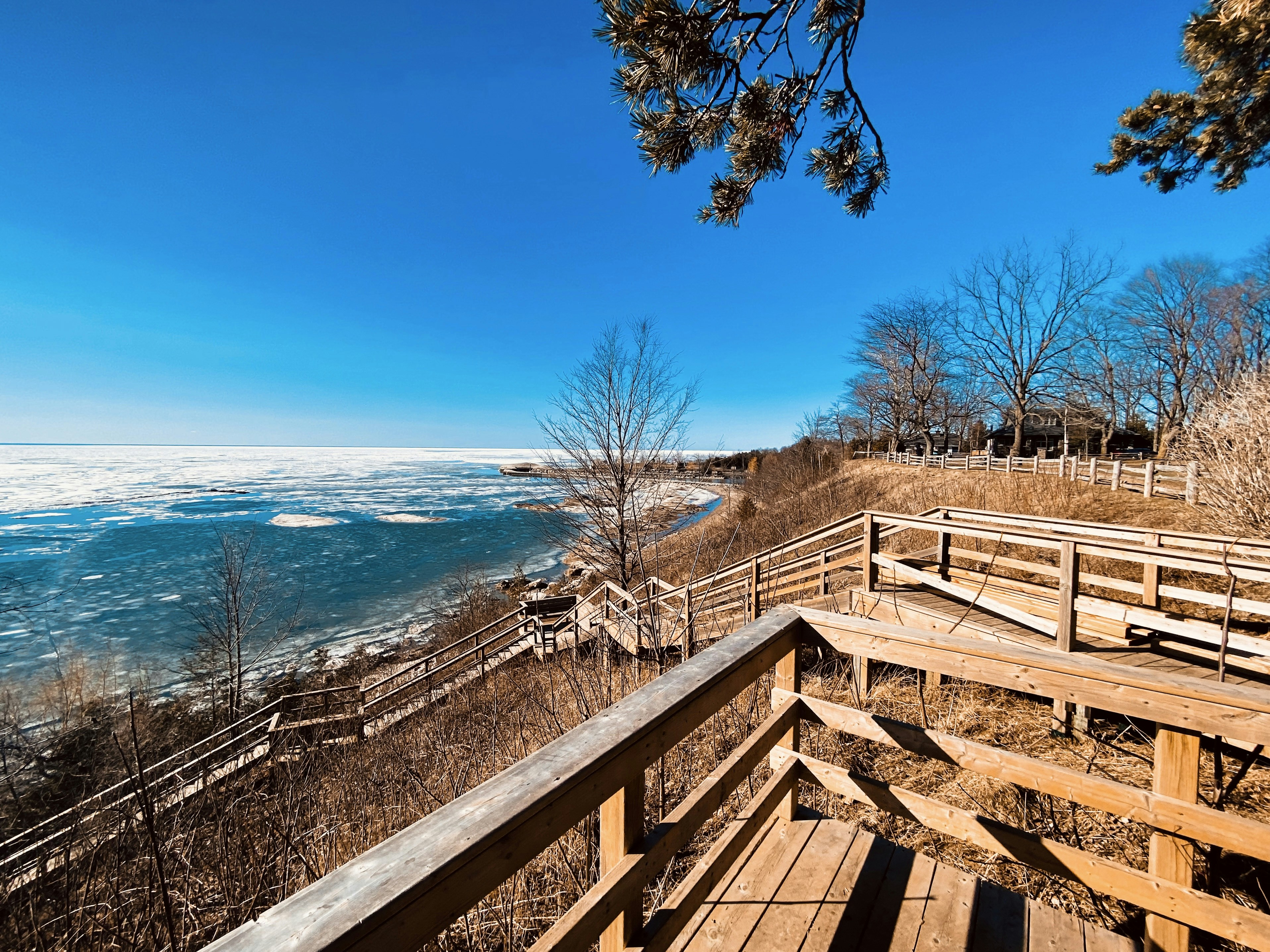 Azure Promenade: Wooden Steps Along a Frigid Seascape