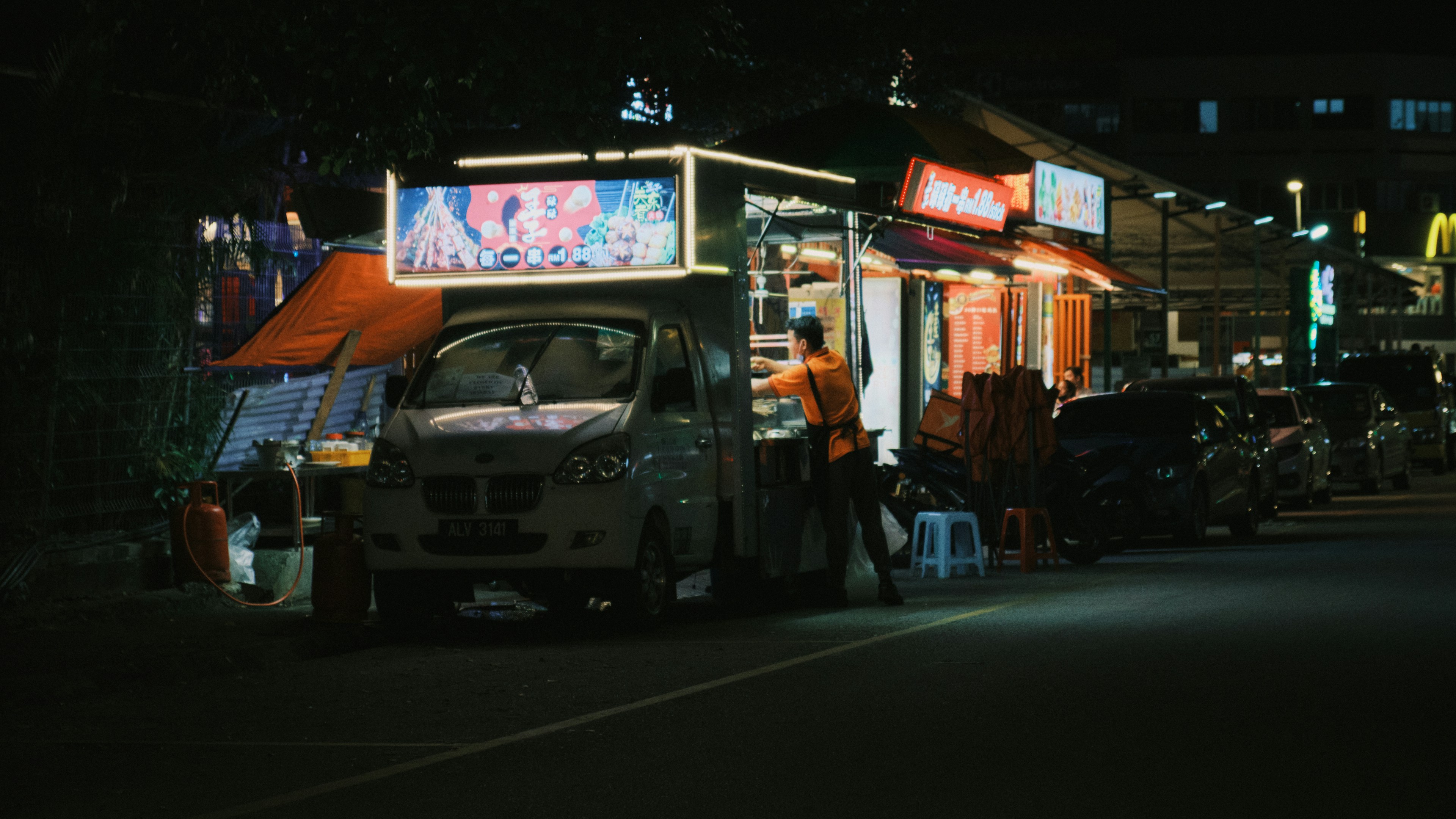 Night Market Stall: Neon Lights, Busy Vendor, Quiet Street