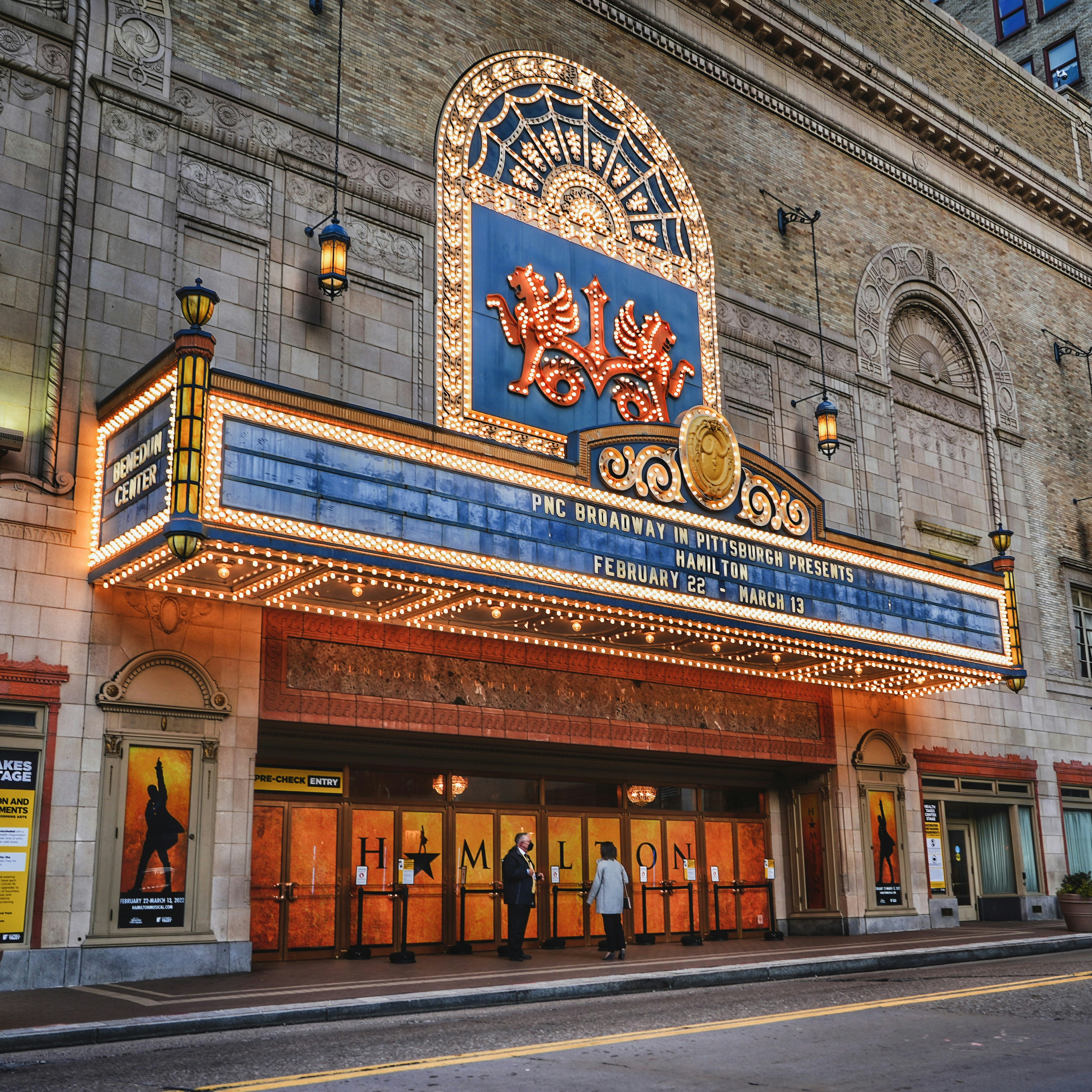 A movie theater with people standing outside of it photo – Free ...