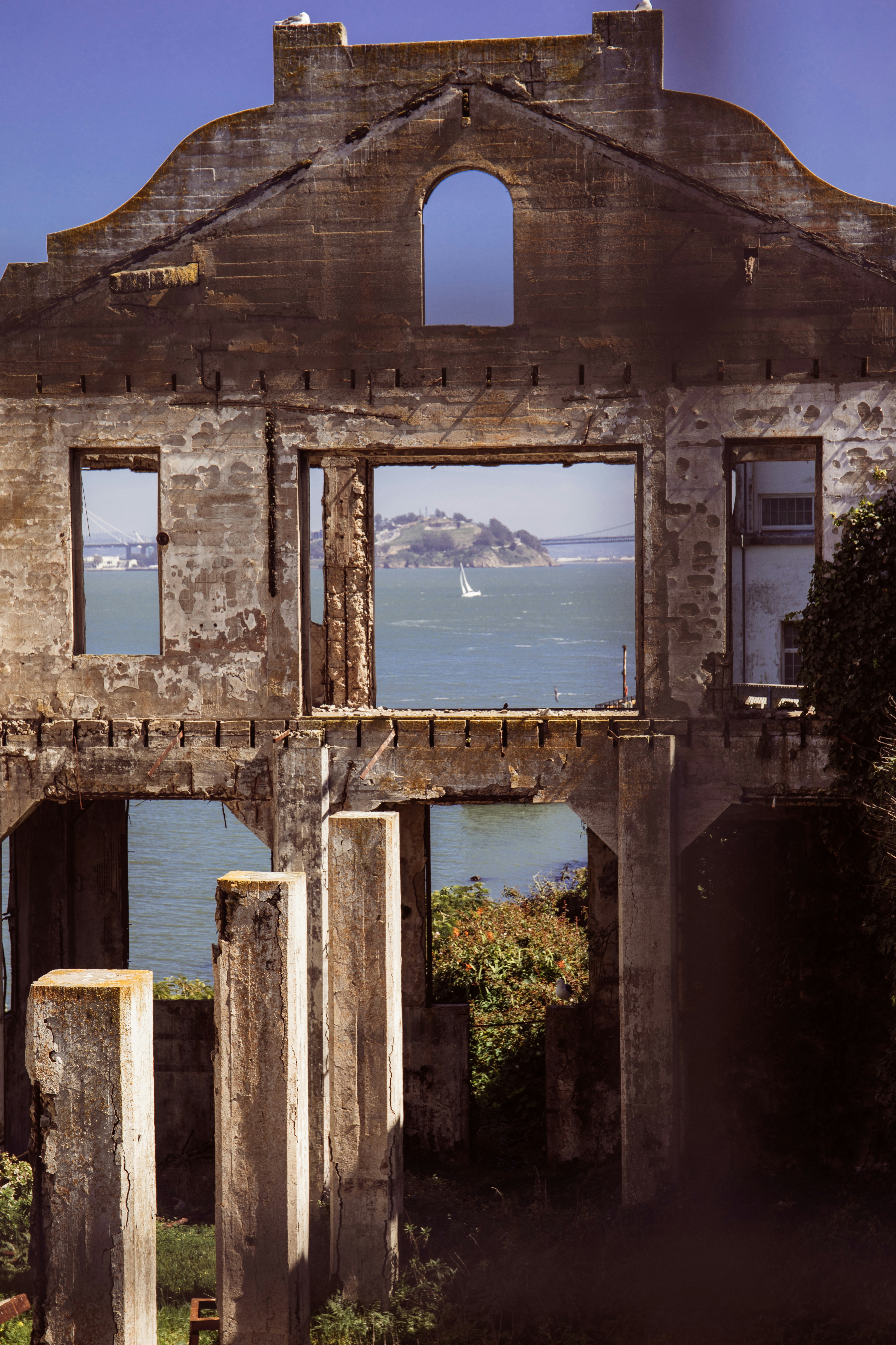 Framed by Time: A Sea-Facing Ruin Revealing a Distant Sailboat