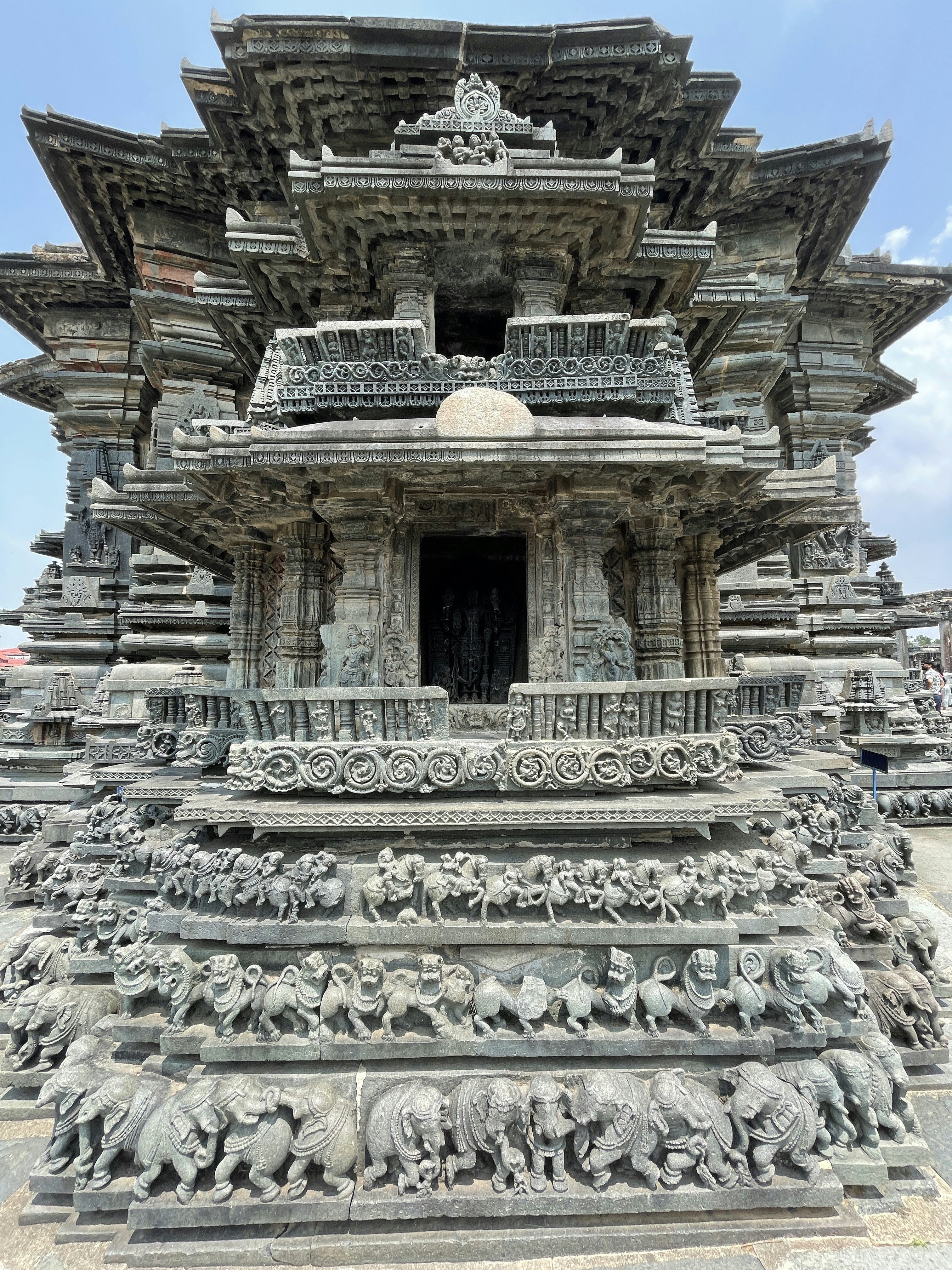 Detailed stone carvings depicting various figures and animals on a temple's façade, showcasing exquisite craftsmanship and cultural heritage.