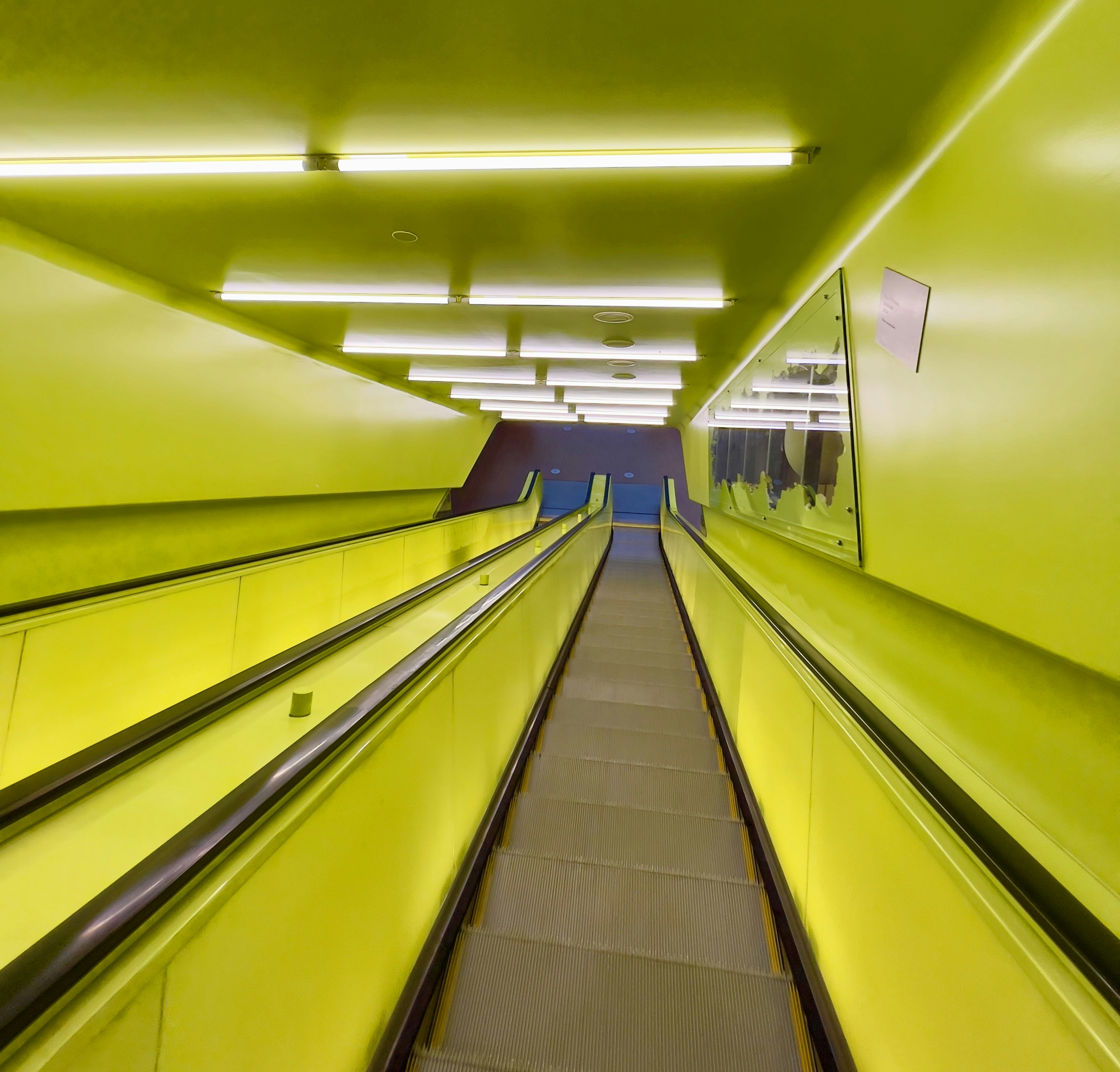 An escalator in a building with yellow walls photo – Free The seattle ...