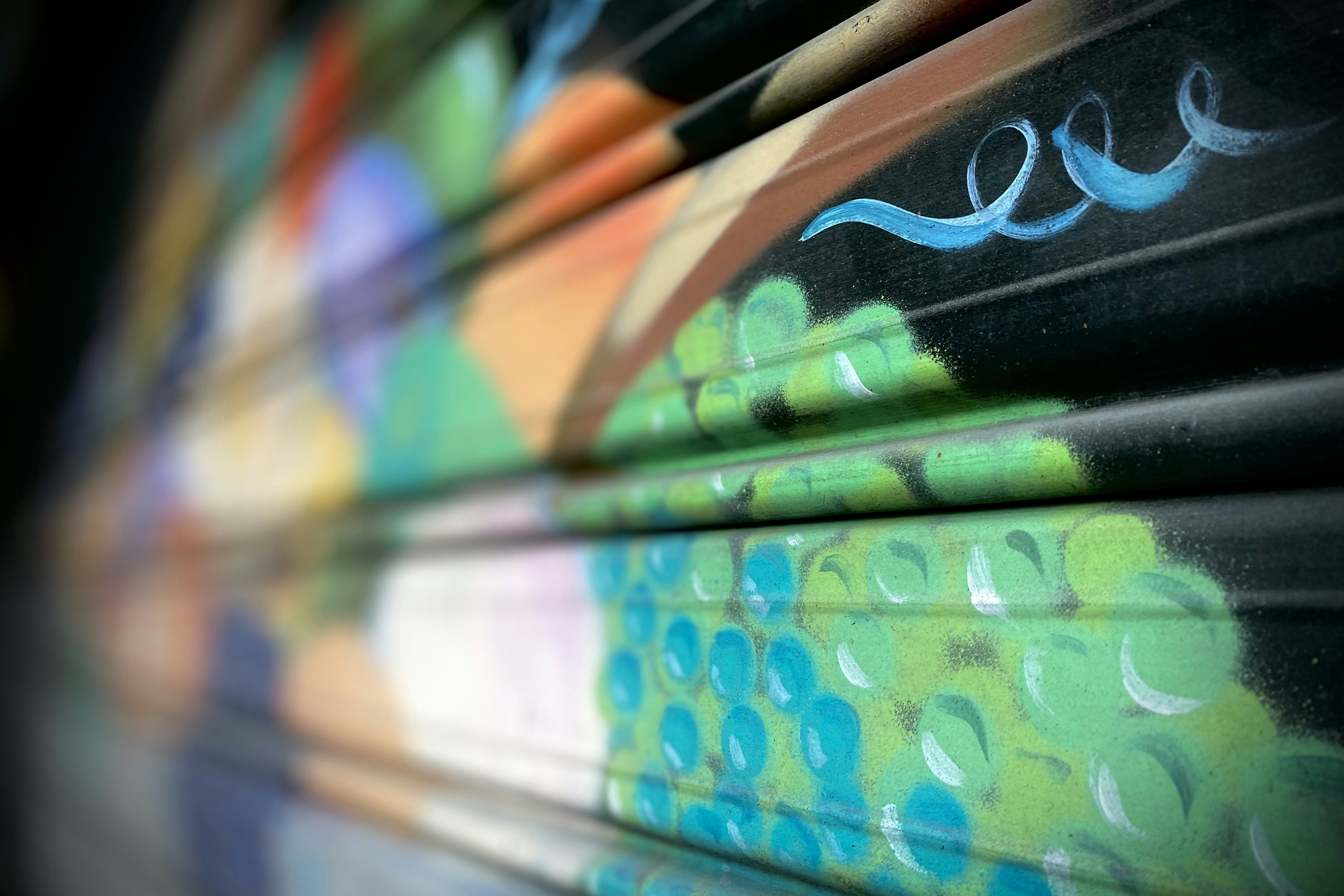Tilted Graffiti: Colorful Strata on a Shutter's Edge