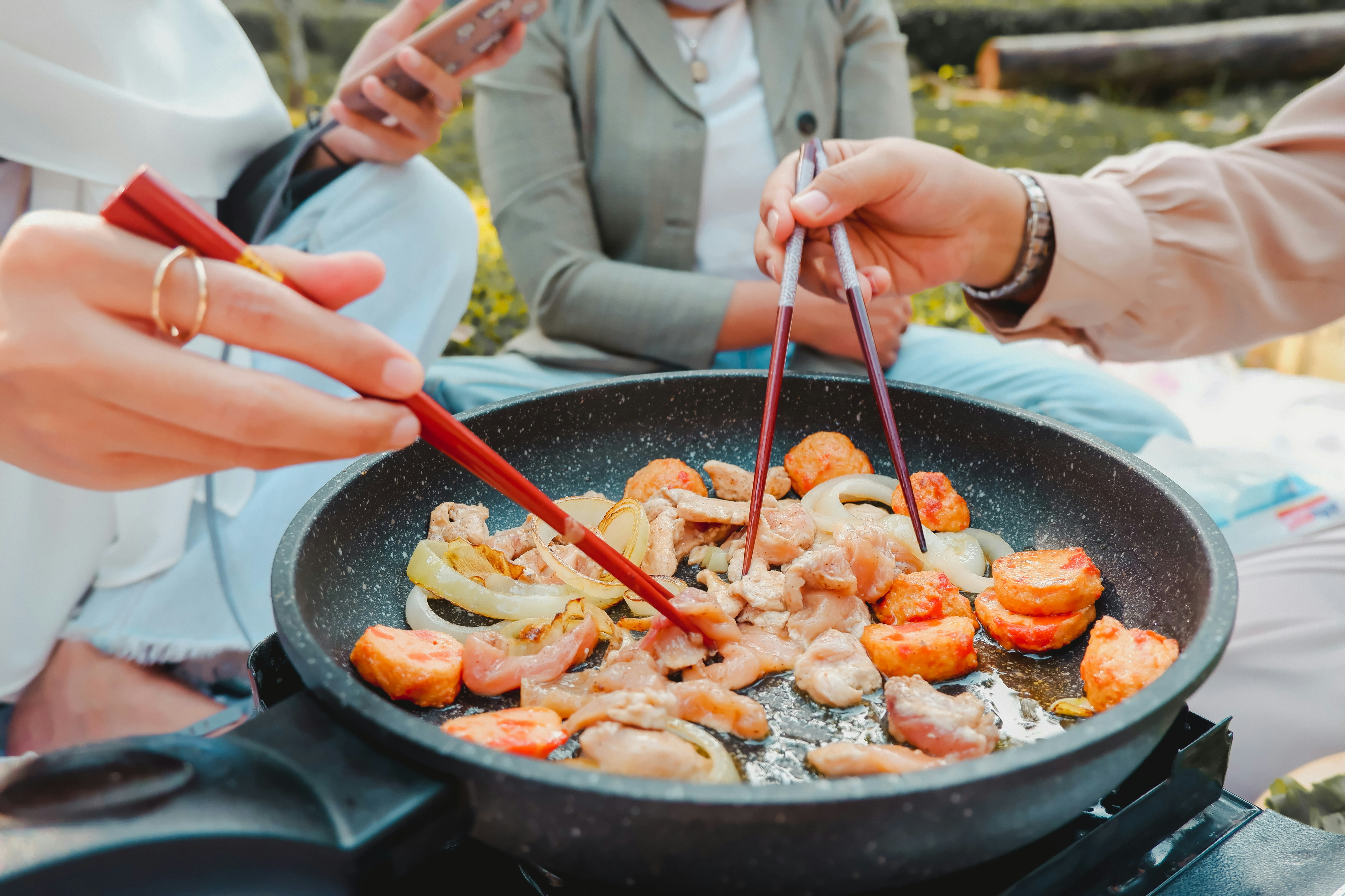 Two people cooking food in a pan on a stove photo – Free Food Image on ...
