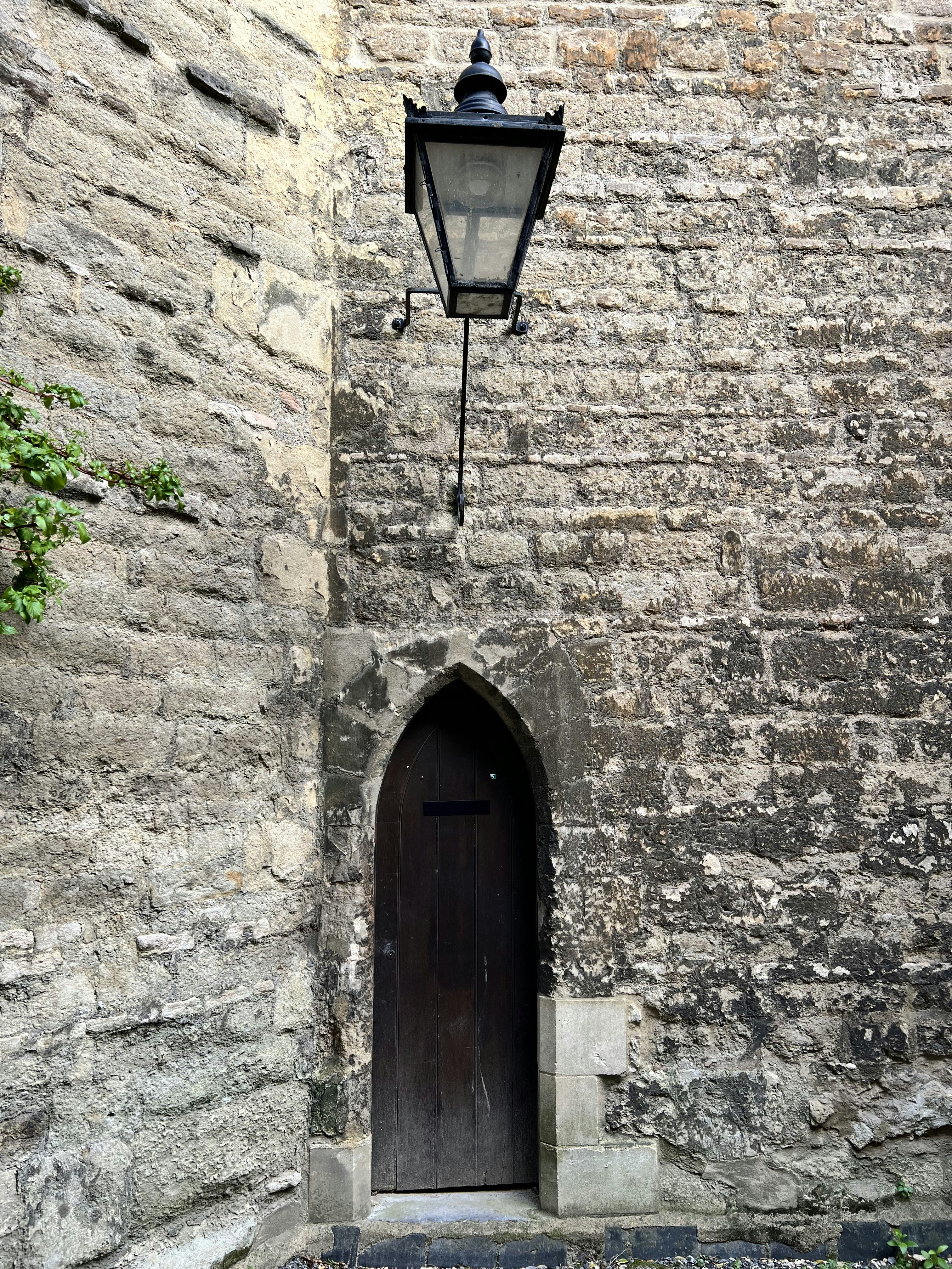 Lantern Above the Arch: Weathered Stone Doorway