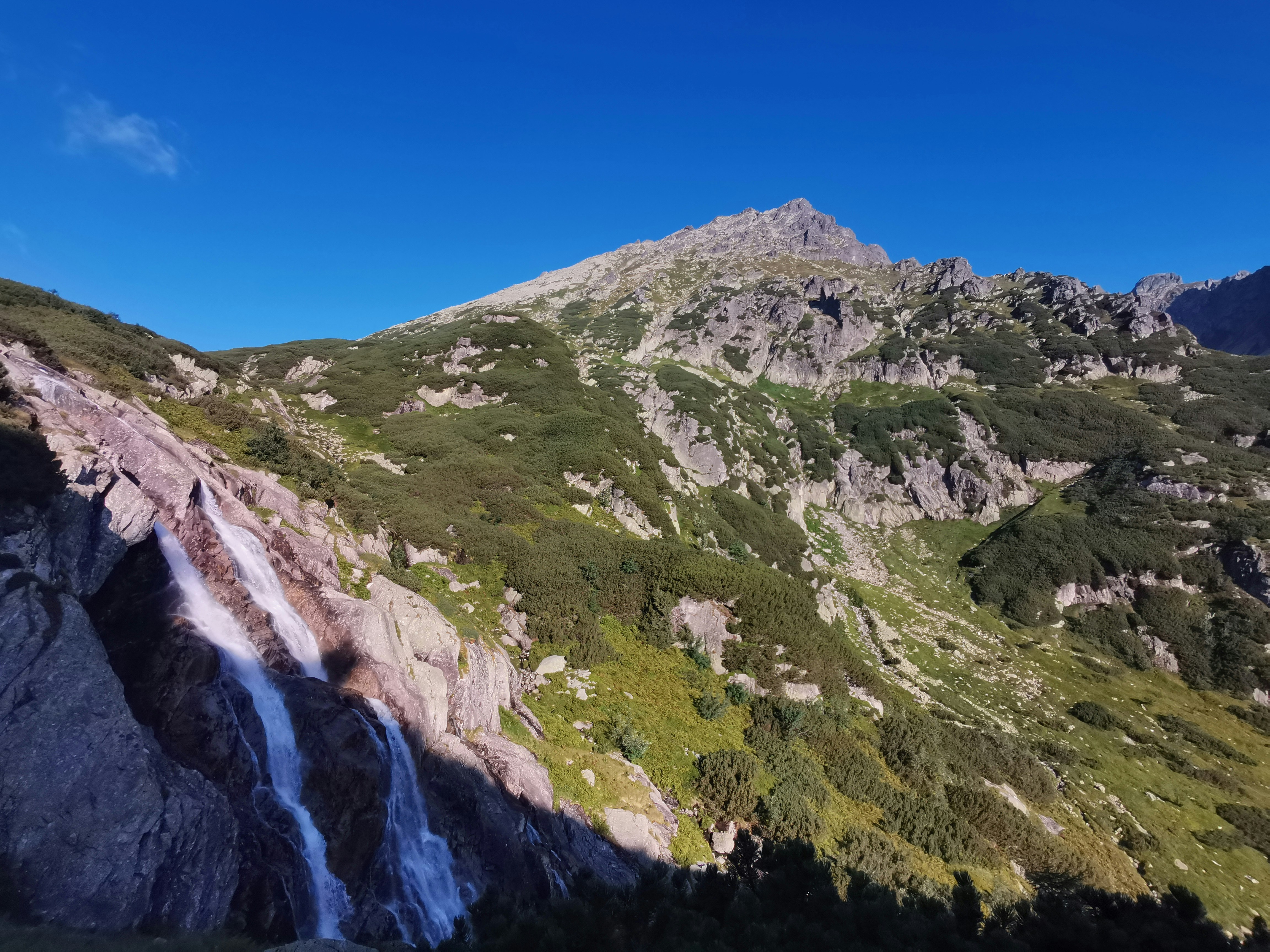 a view of a mountain with a waterfall