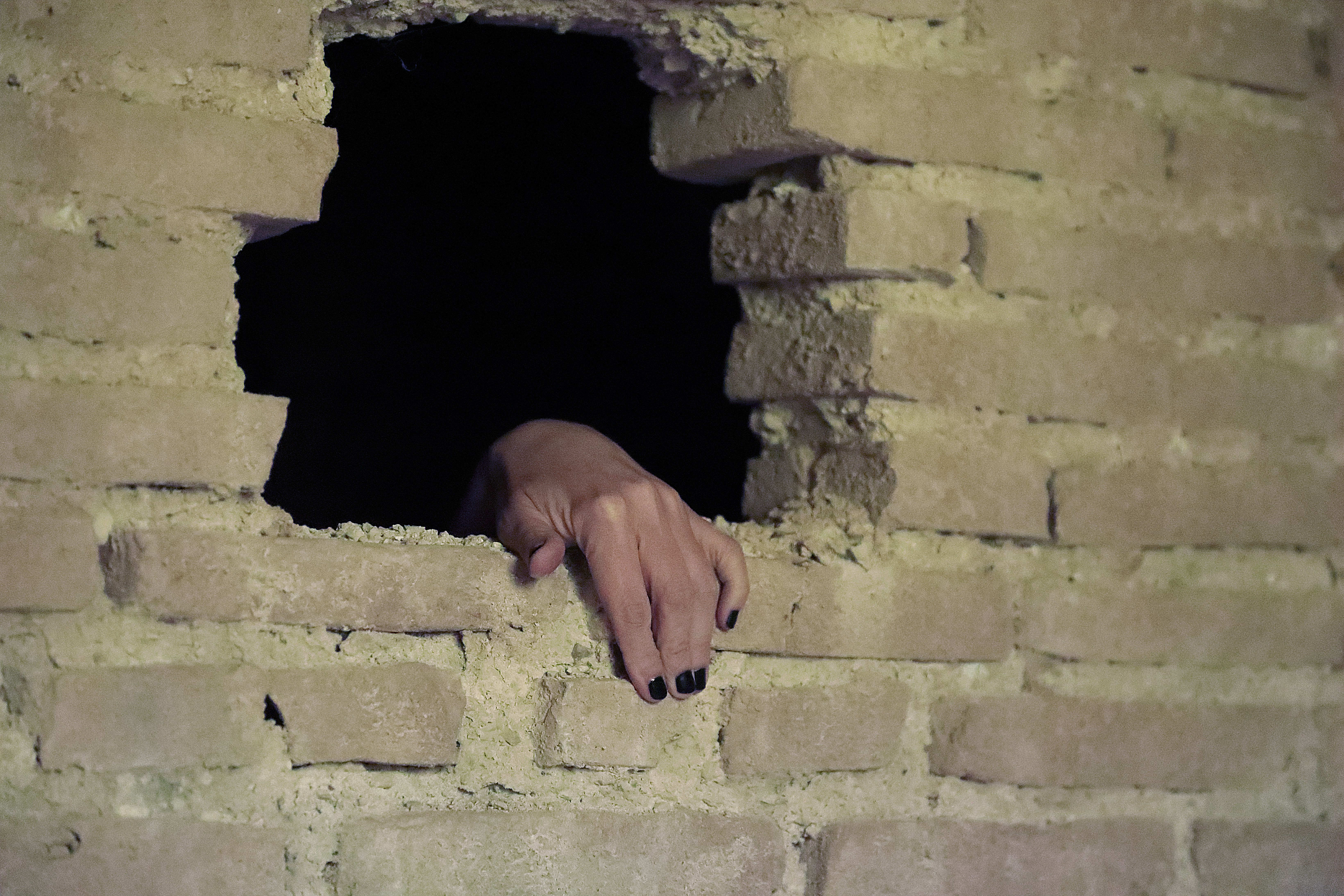 Out of the Brick Gap: A Grasp Through the Wall