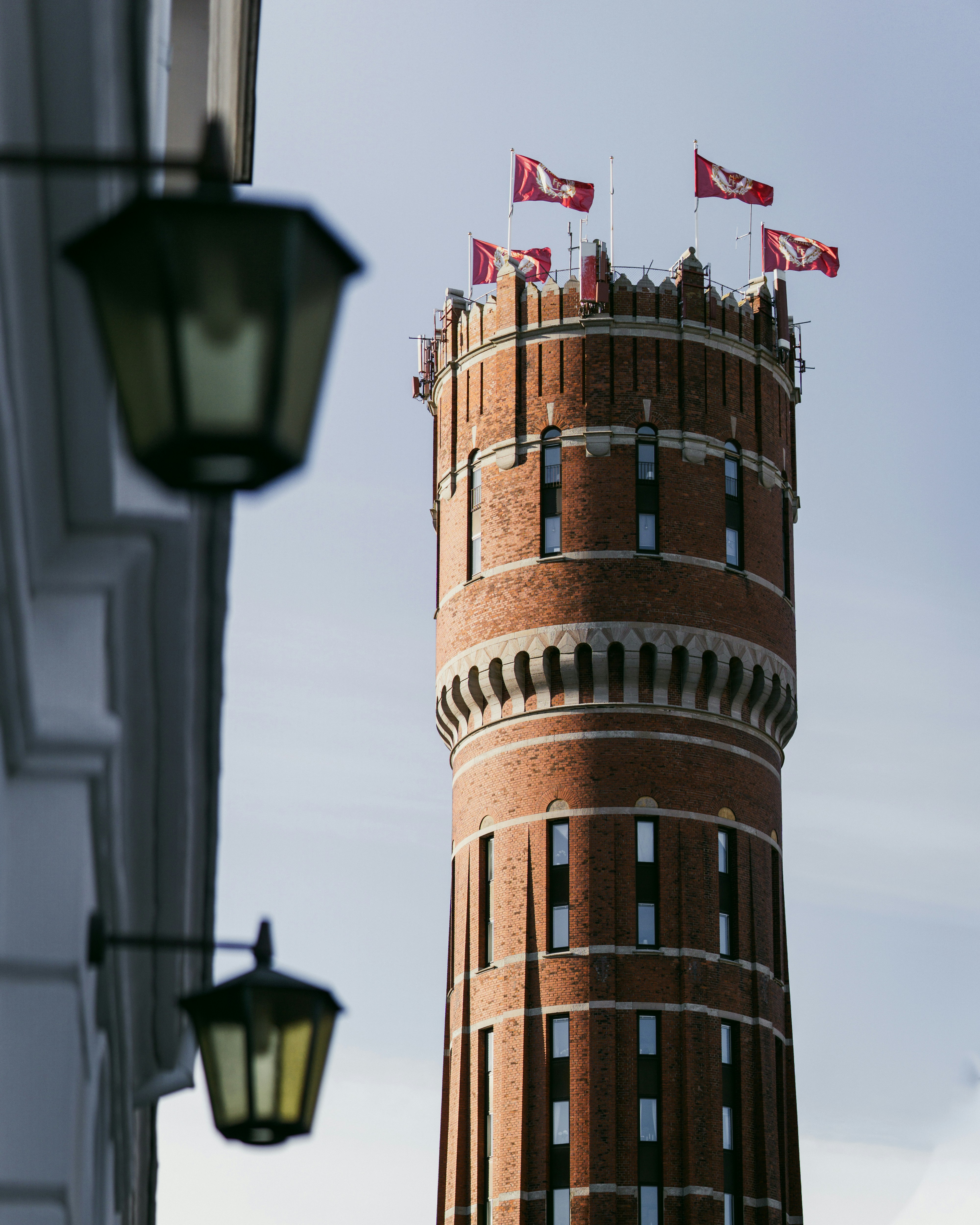 A tall brick tower with flags on top of it photo – Free Kalmar Image on ...
