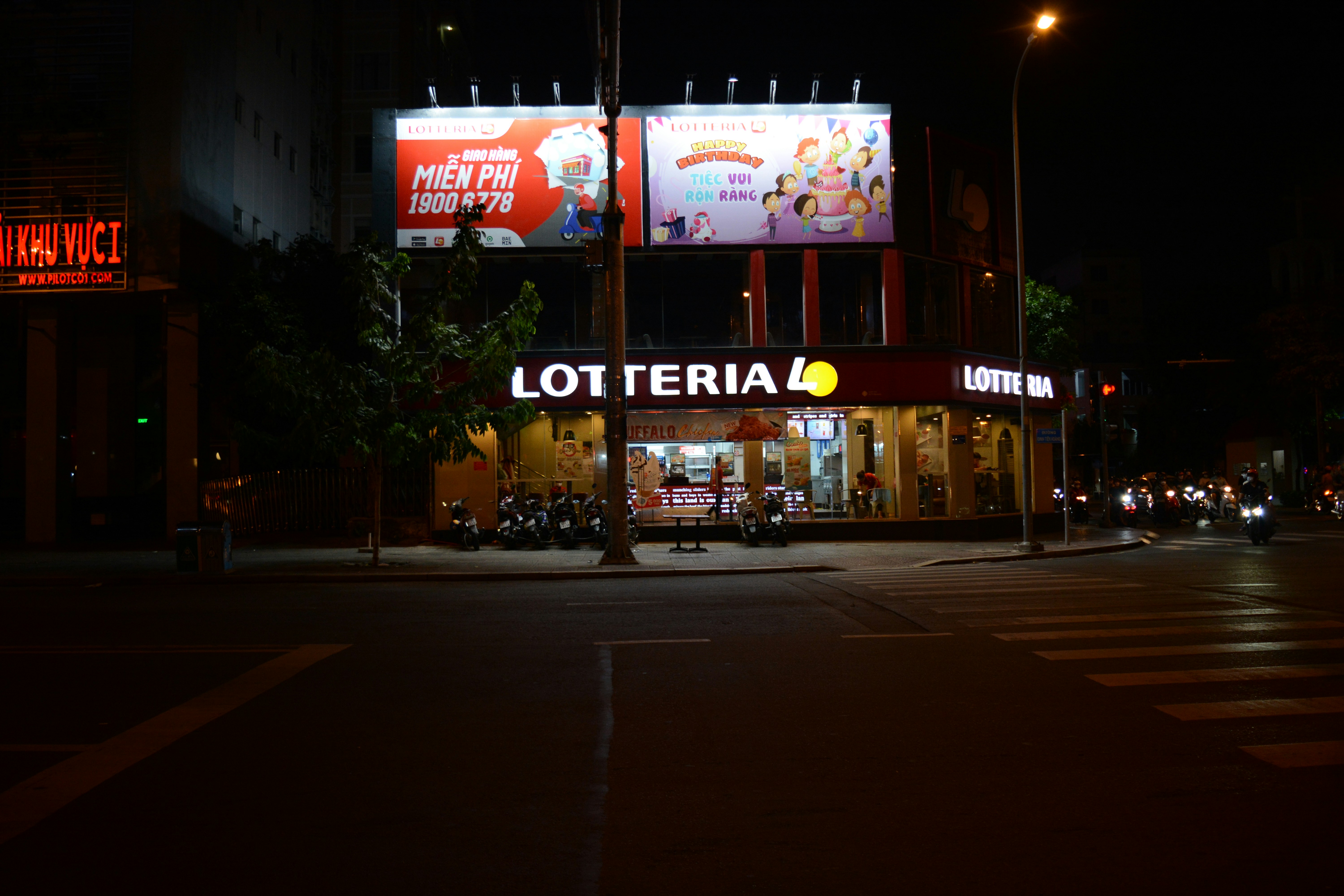 A store front at night with a lotteria sign lit up photo – Free ...