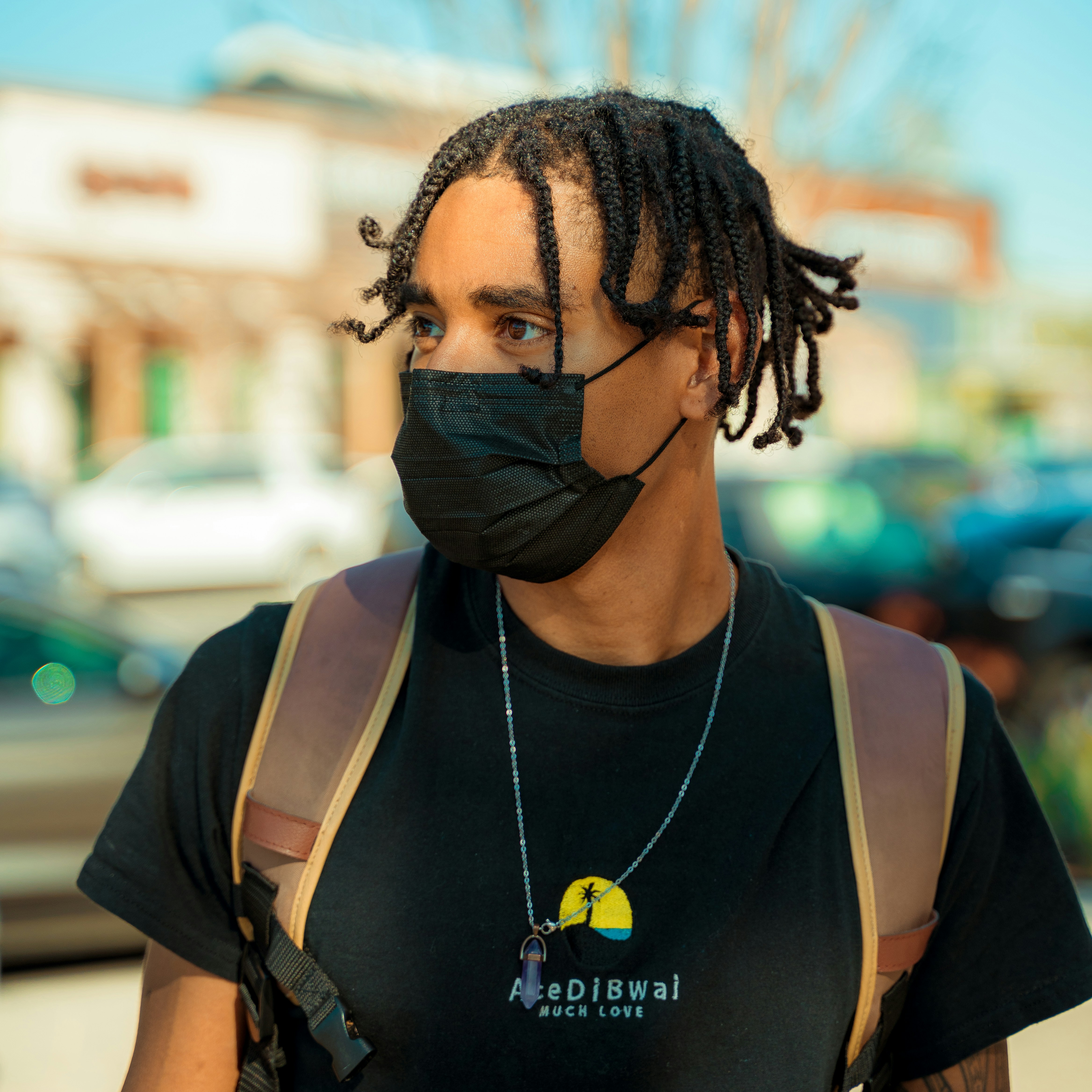 A man with dreadlocks wearing a black face mask photo – Free Brown ...