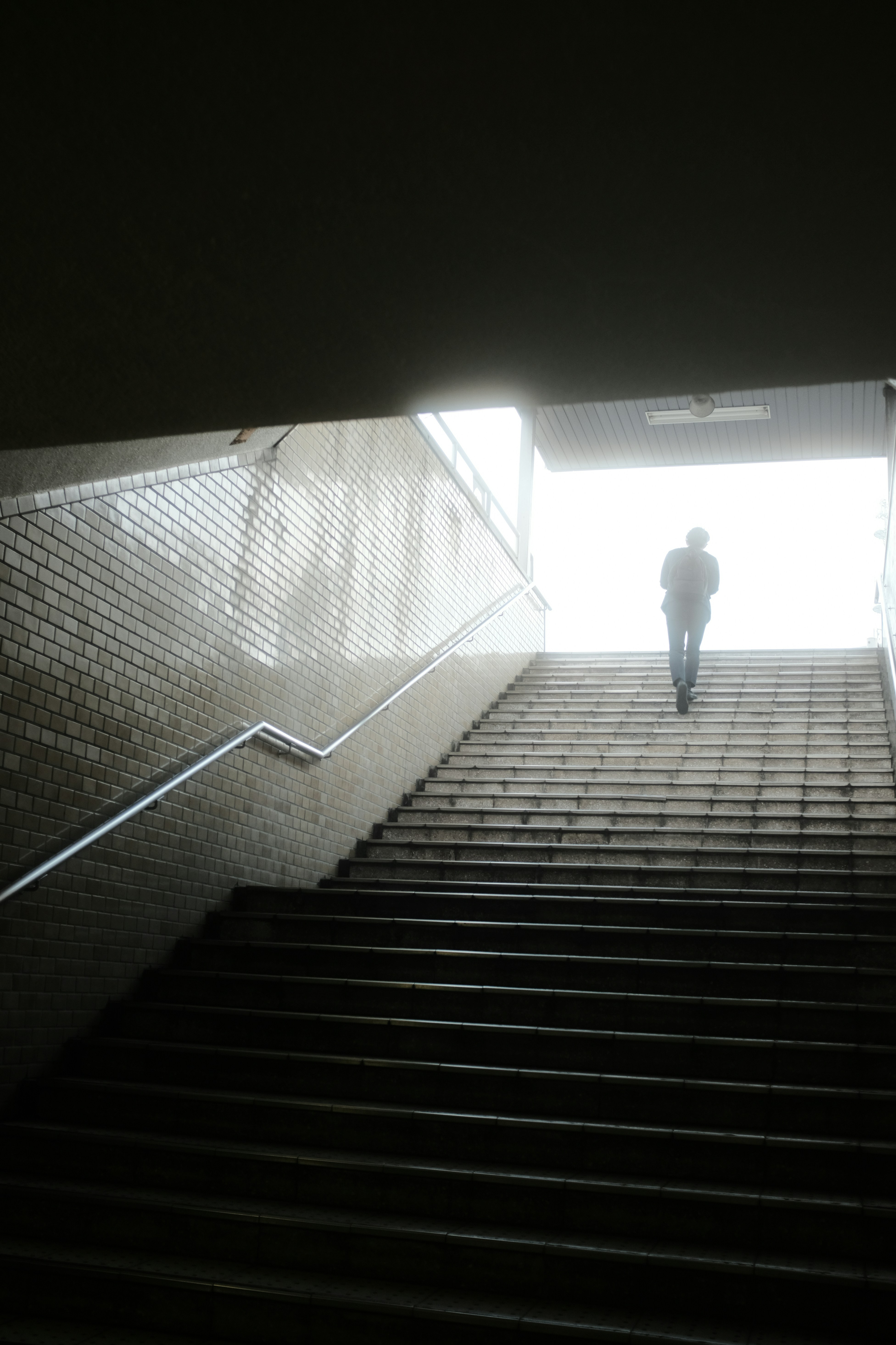 A man walking up a flight of stairs photo – Free Grey Image on Unsplash