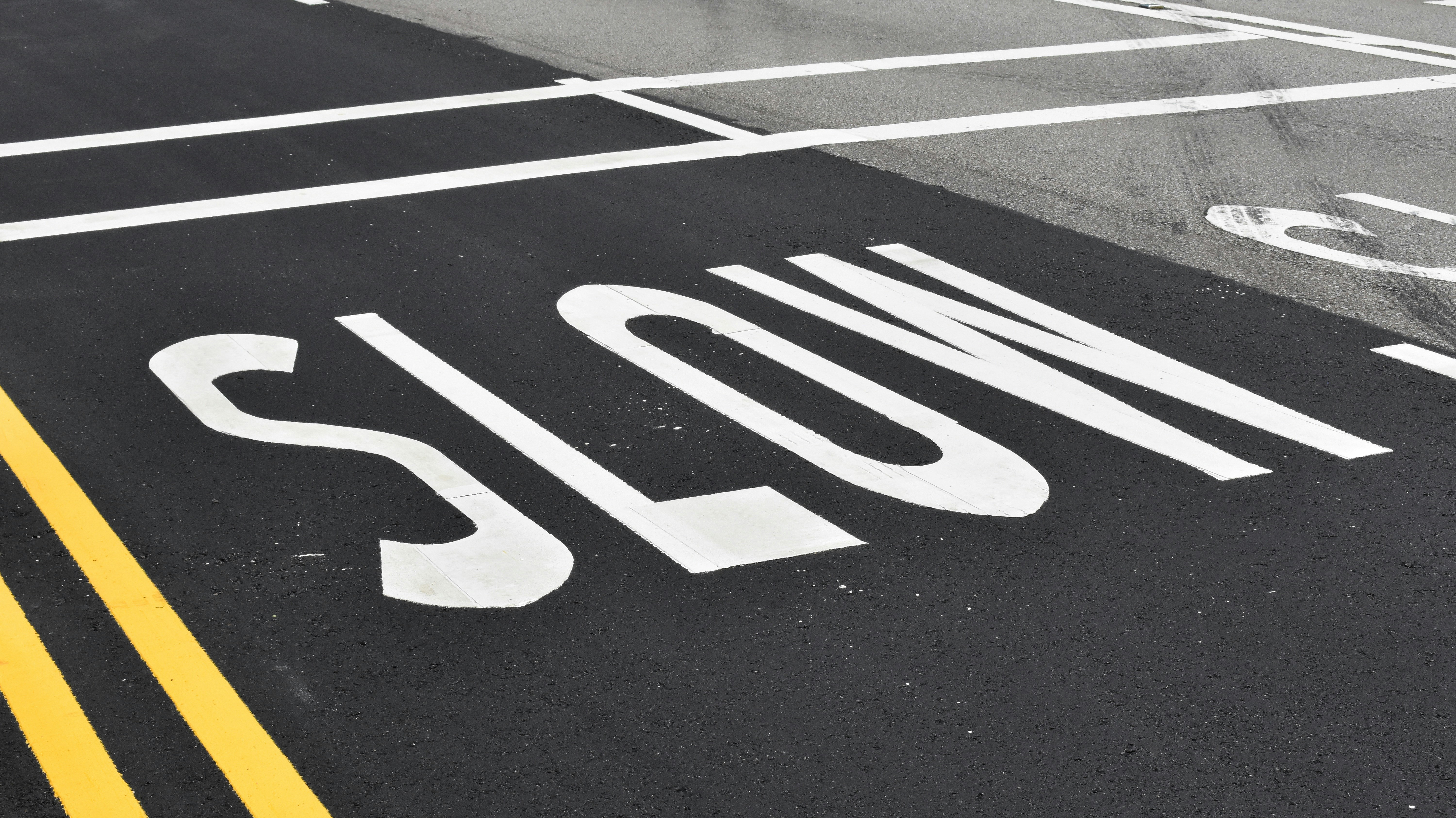 A parking lot with the word slow painted on it photo – Free Singapore ...