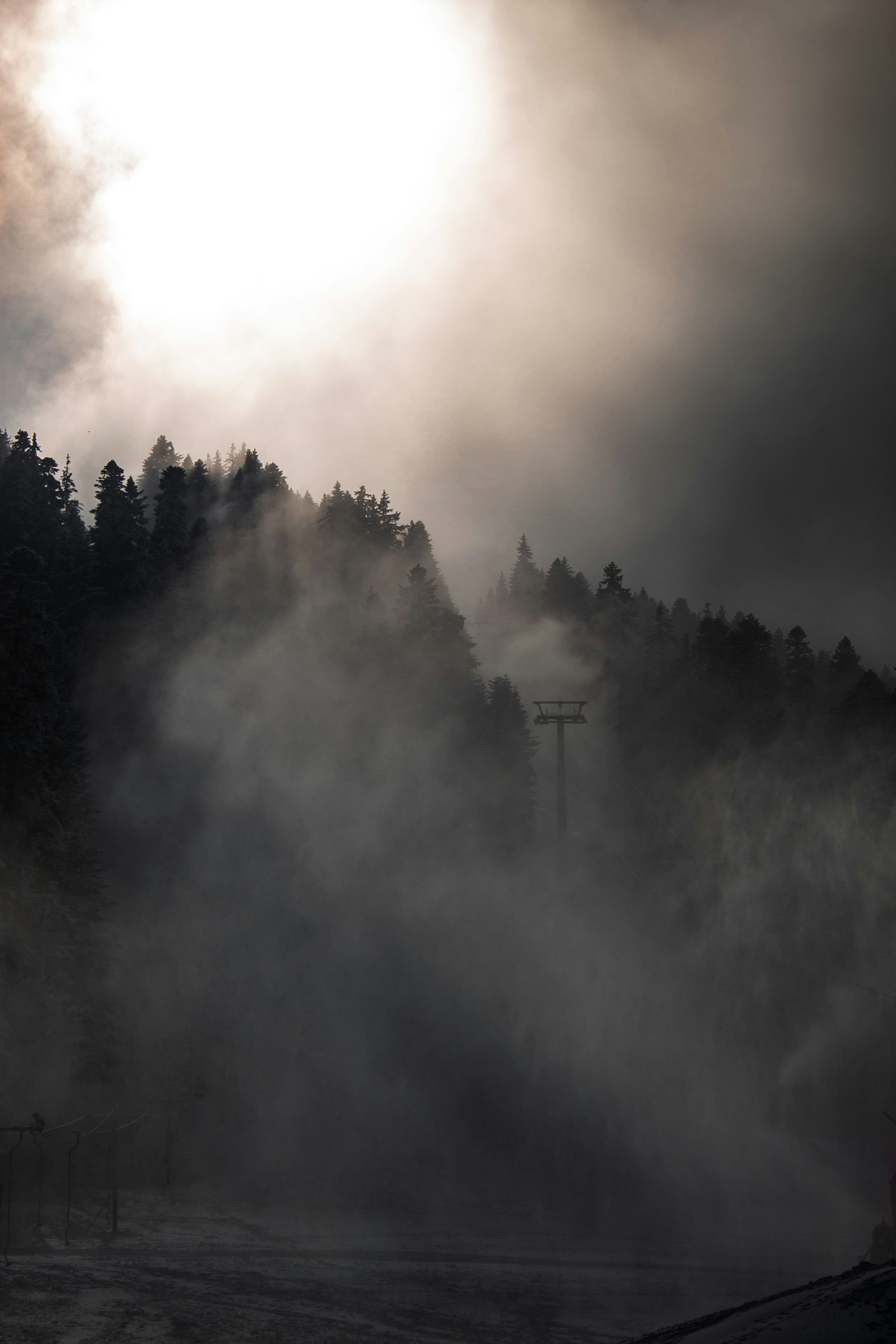 Morning Mist Over the Ridge: A Lone Ski Lift in Quiet Fog